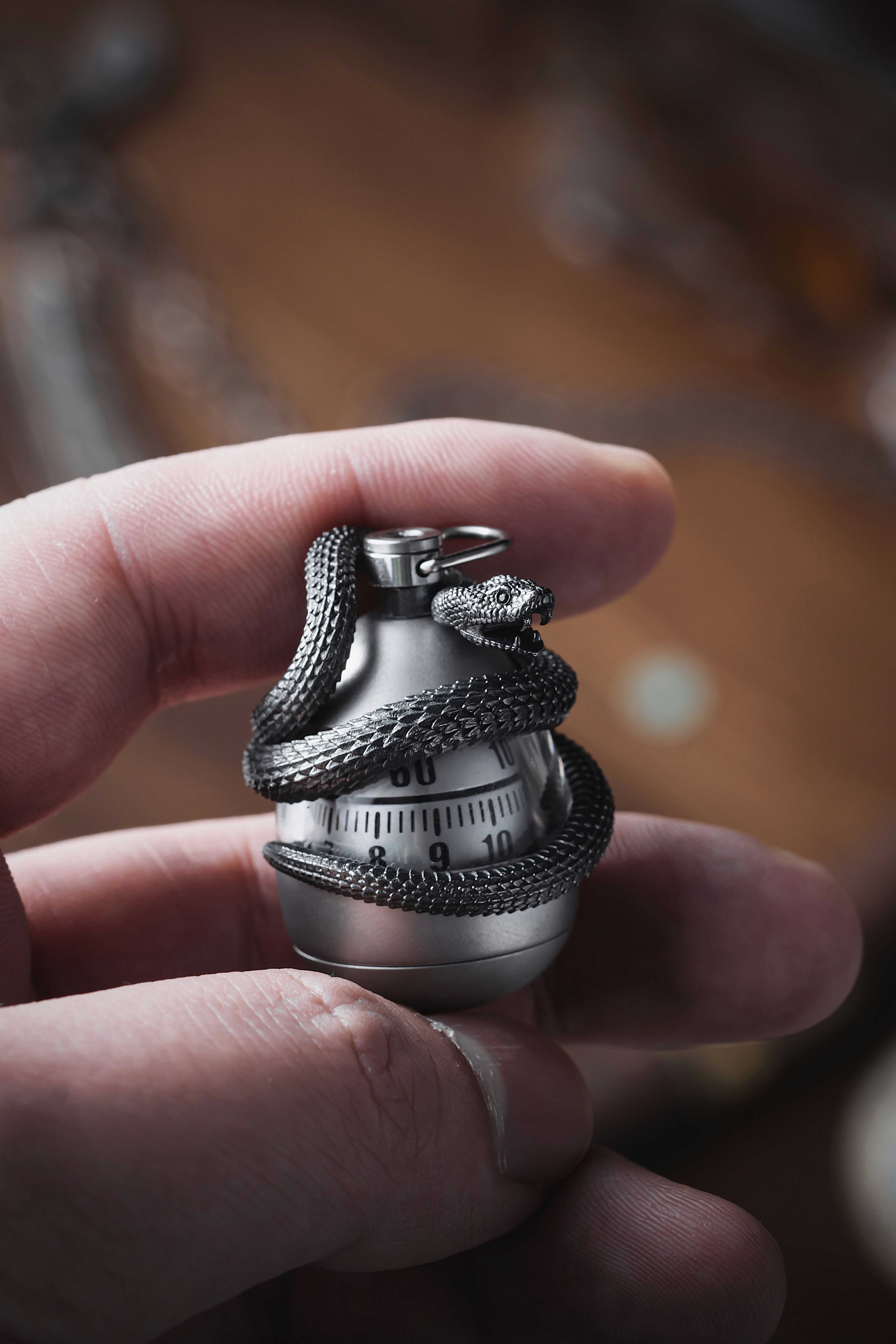 Tiny Stopwatch, Bold Coil: A Metal Snake Wrapped Around Time