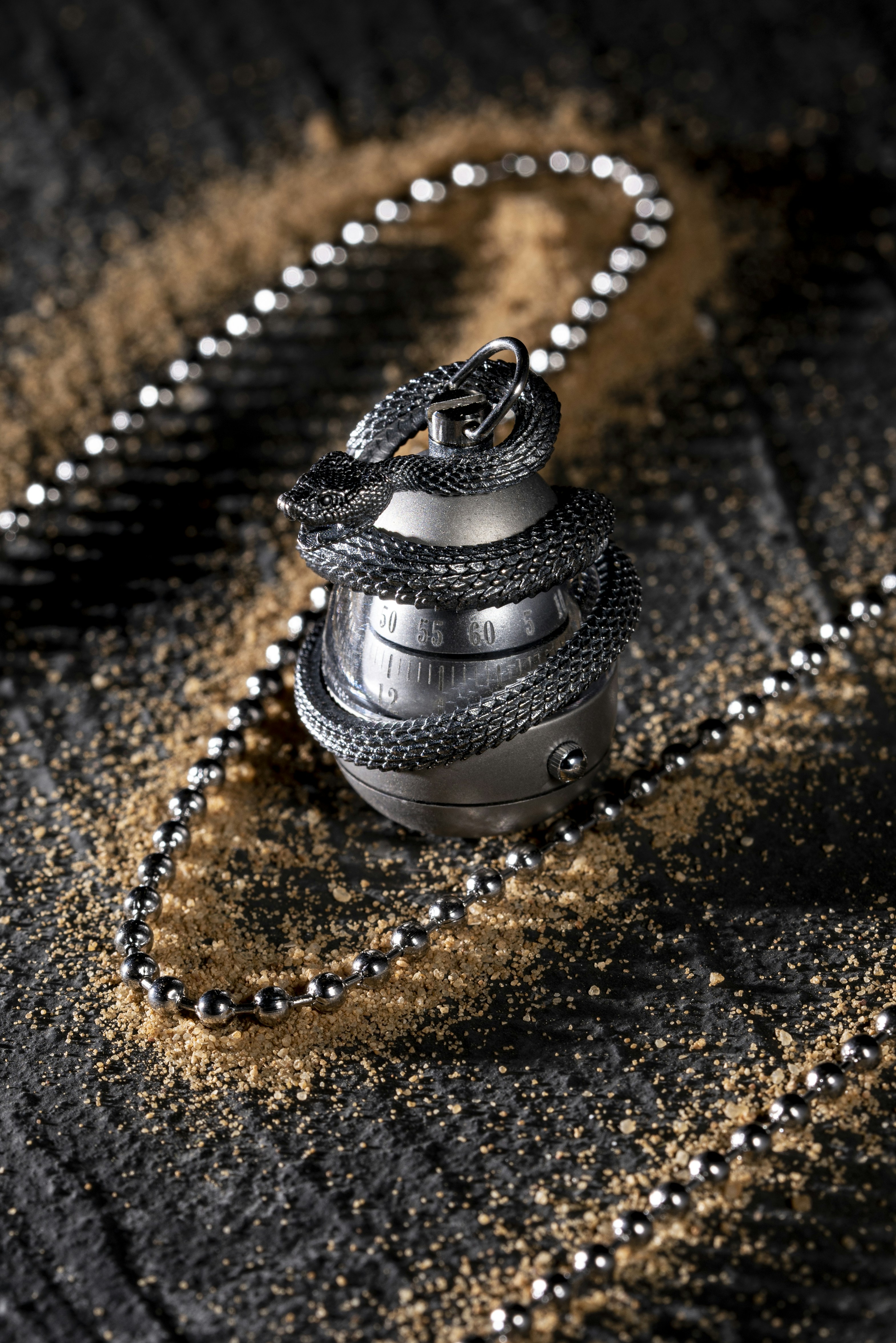 Coiled Time: A Precision Dial Wrapped in Shadowed Sand