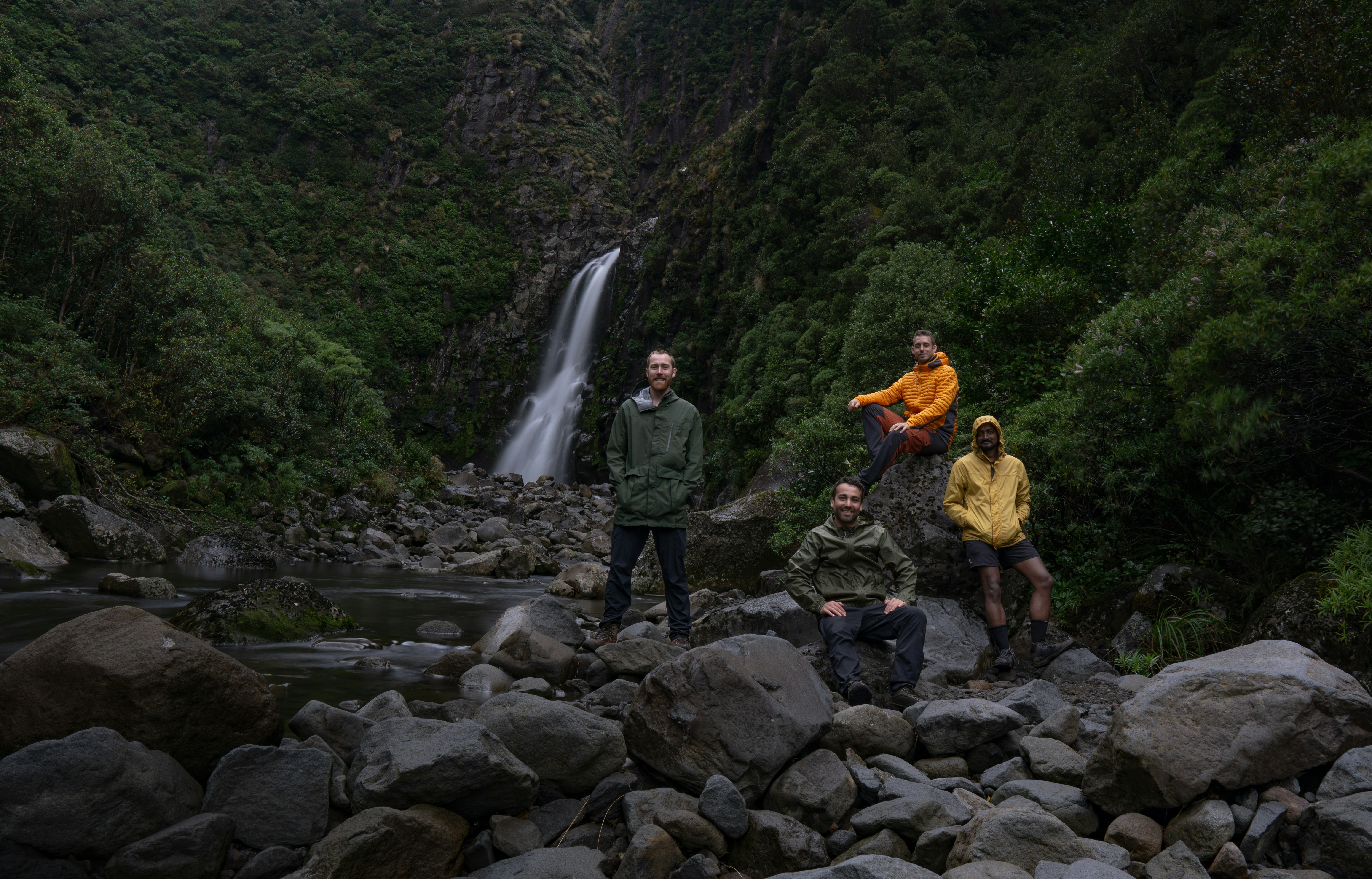 Quartet on the Riverbed Edge Beneath a Hidden Cascade