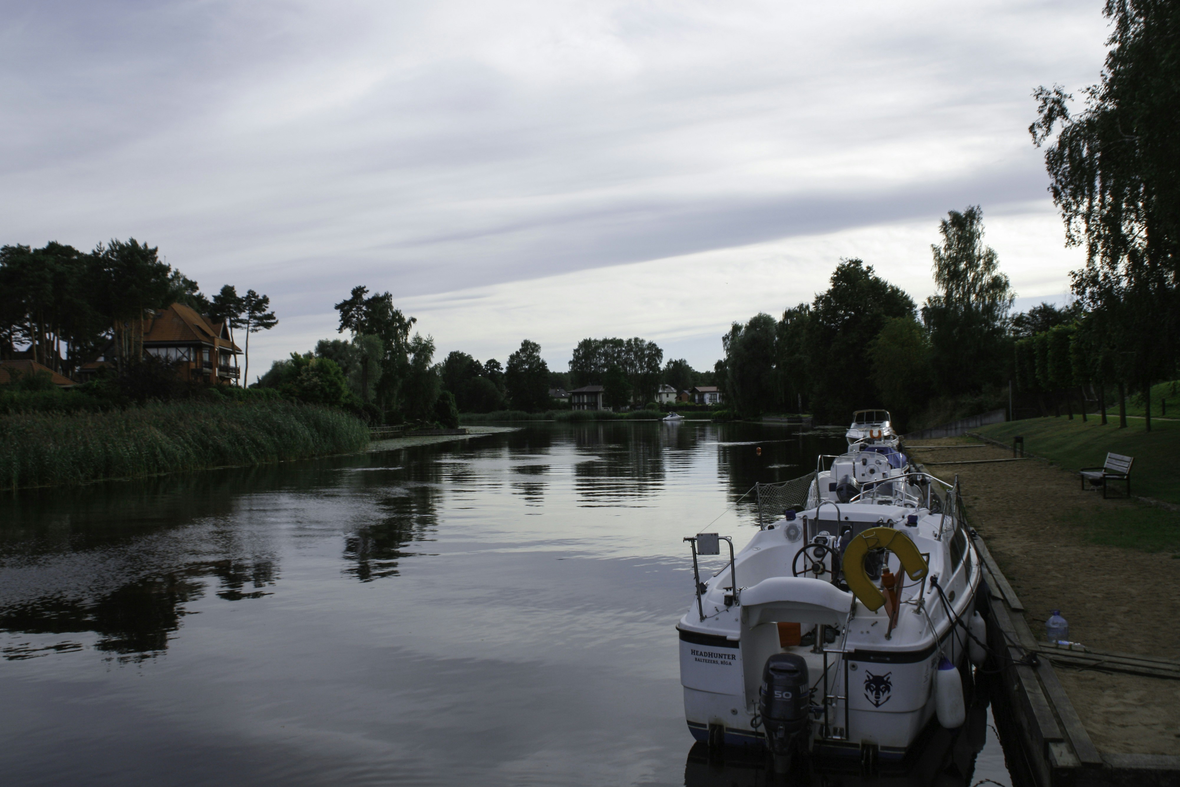 Dockside Quiet: A White Riverboat at the Canal's Edge