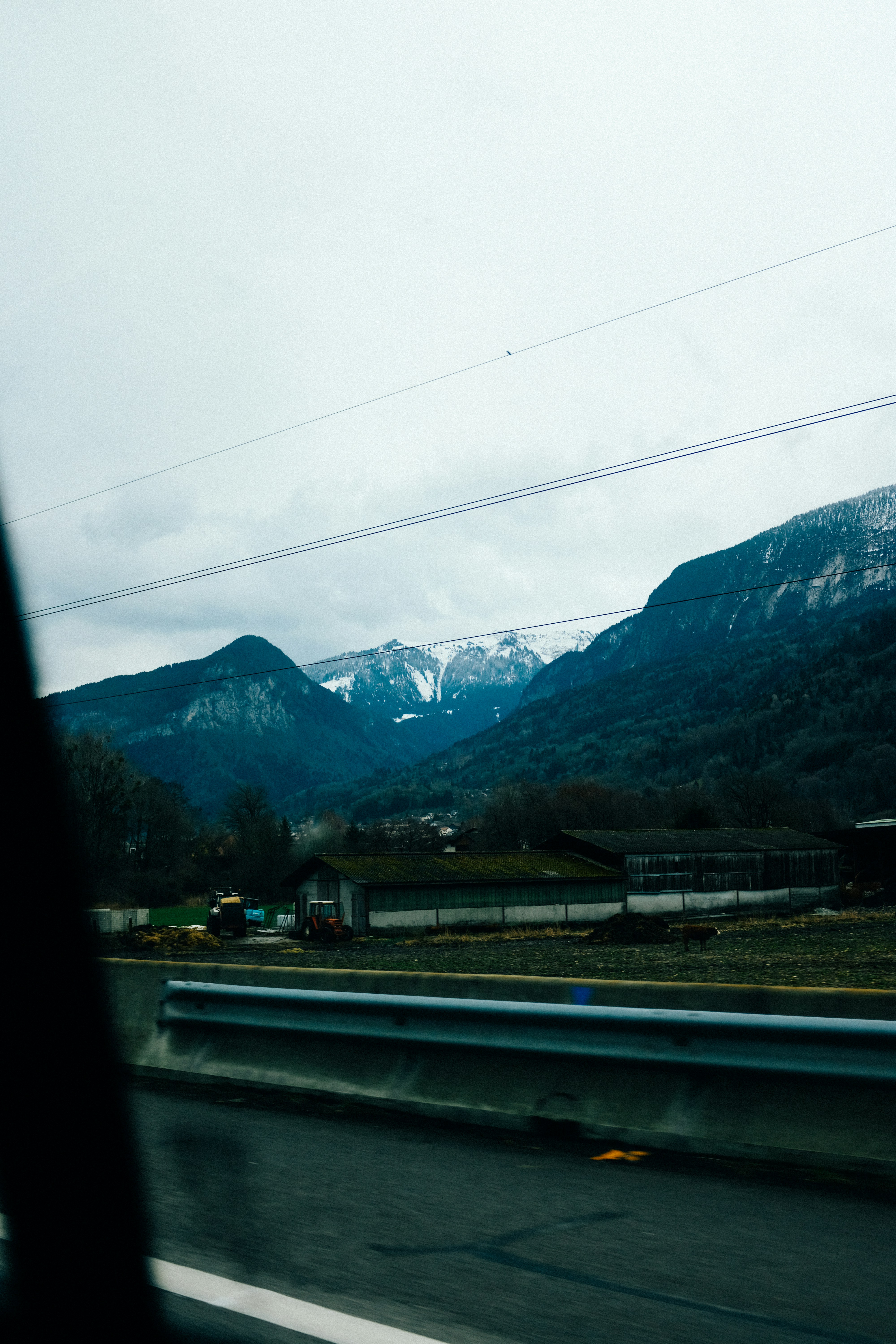 Snow-Capped Ridge Framed by a Moving Vehicle