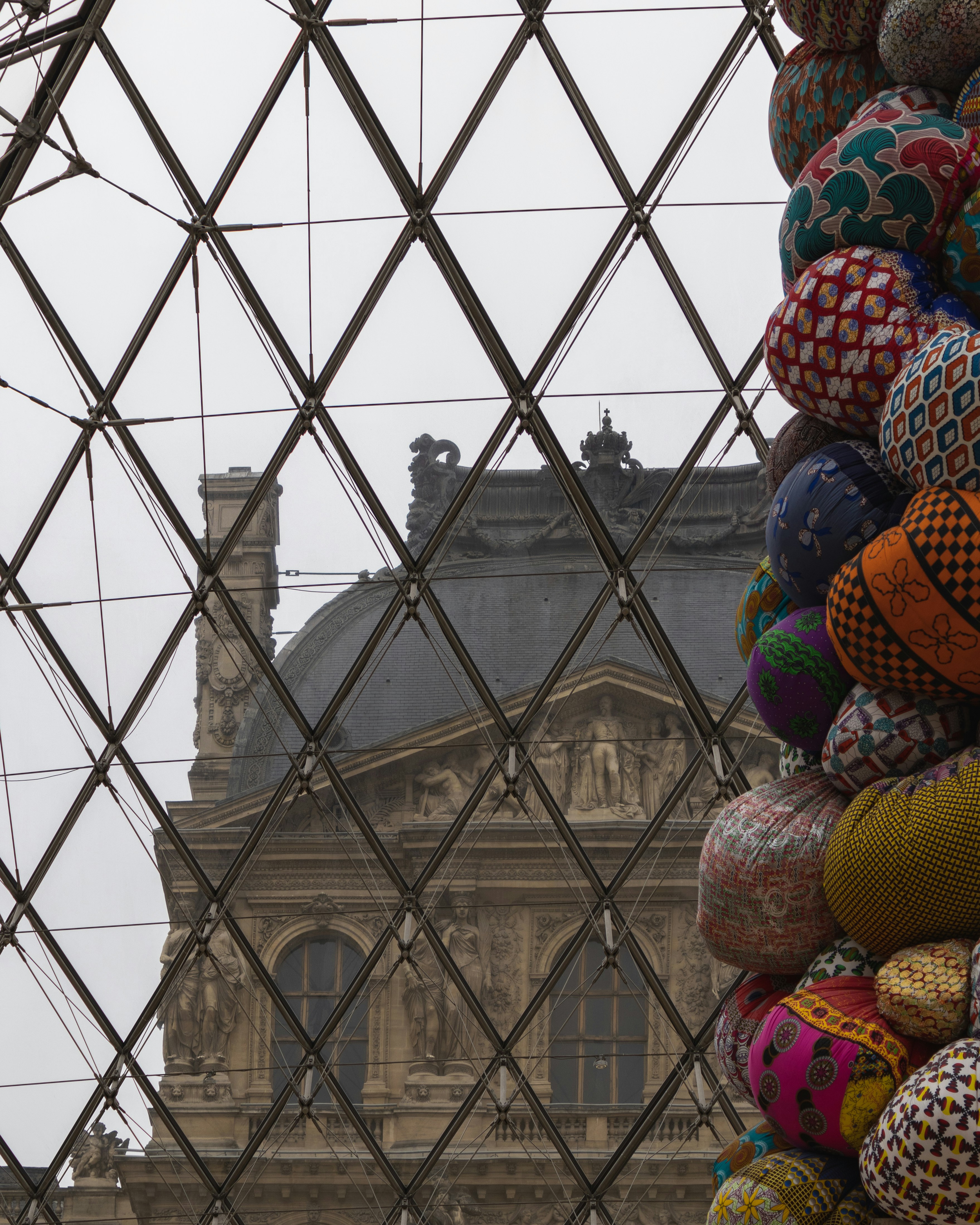 Inside the Glass Cage: Facade of a Historic Building Framed by a Patterned Geodesic Roof