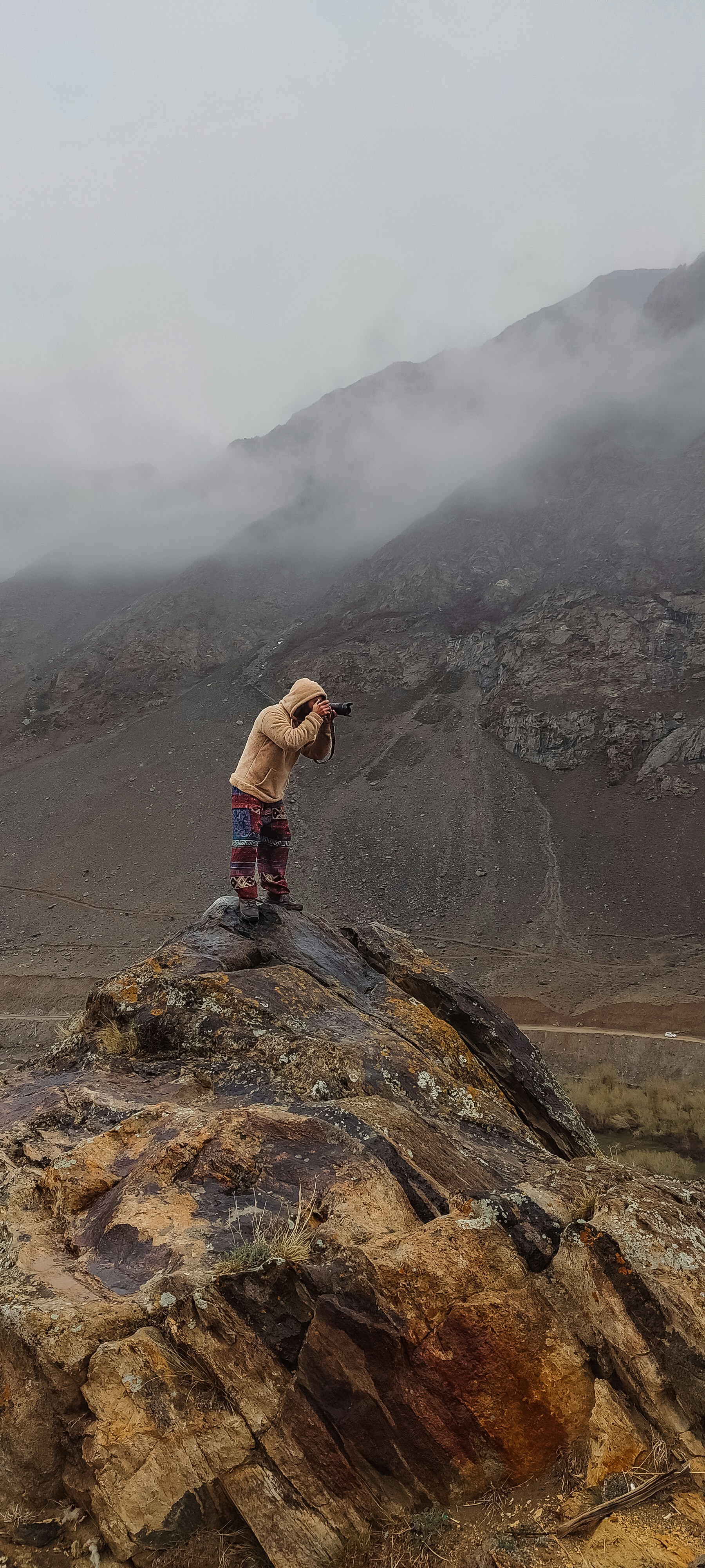 a person standing on top of a large rock