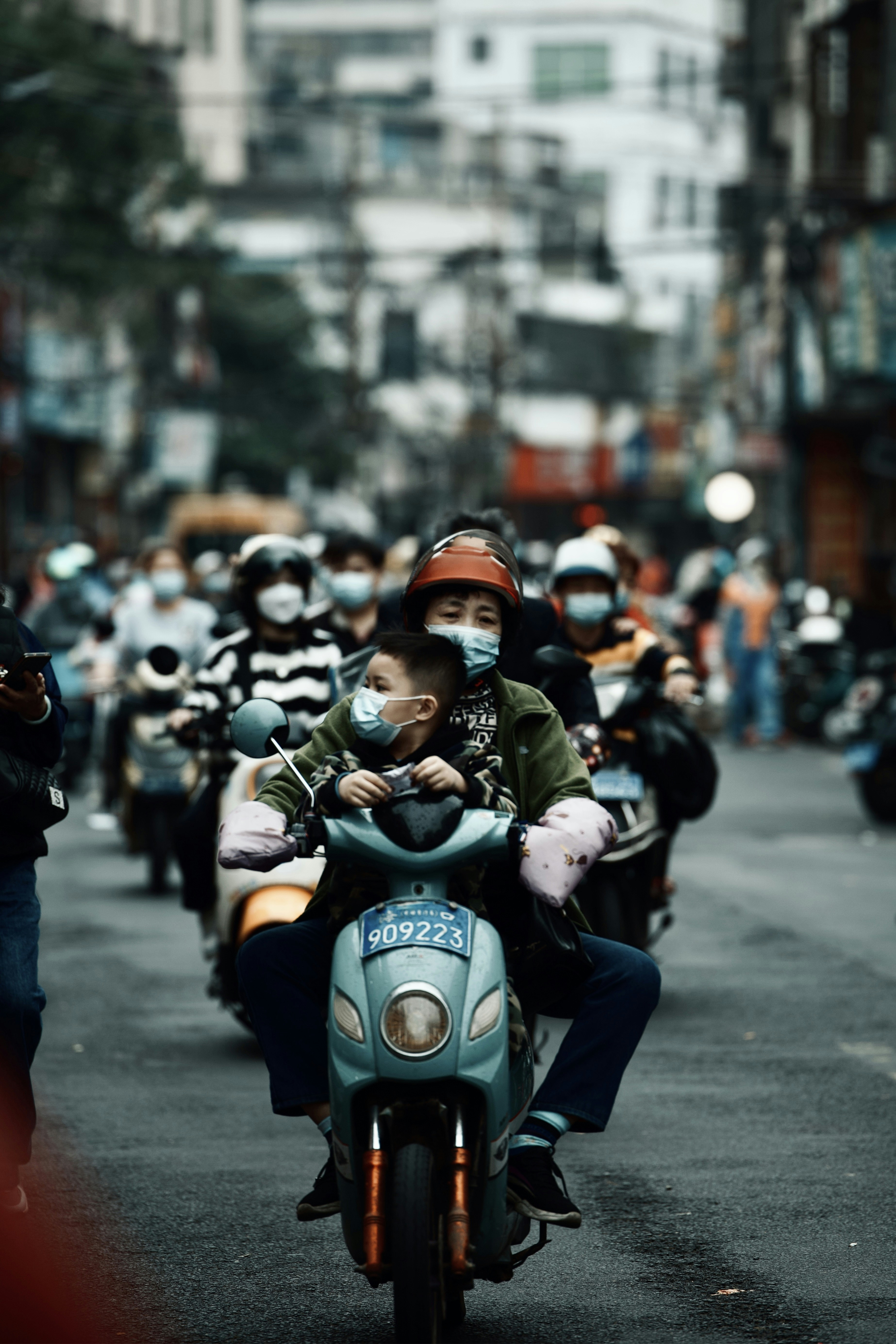 A group of people riding motorcycles down a street photo – Free 海口市 ...