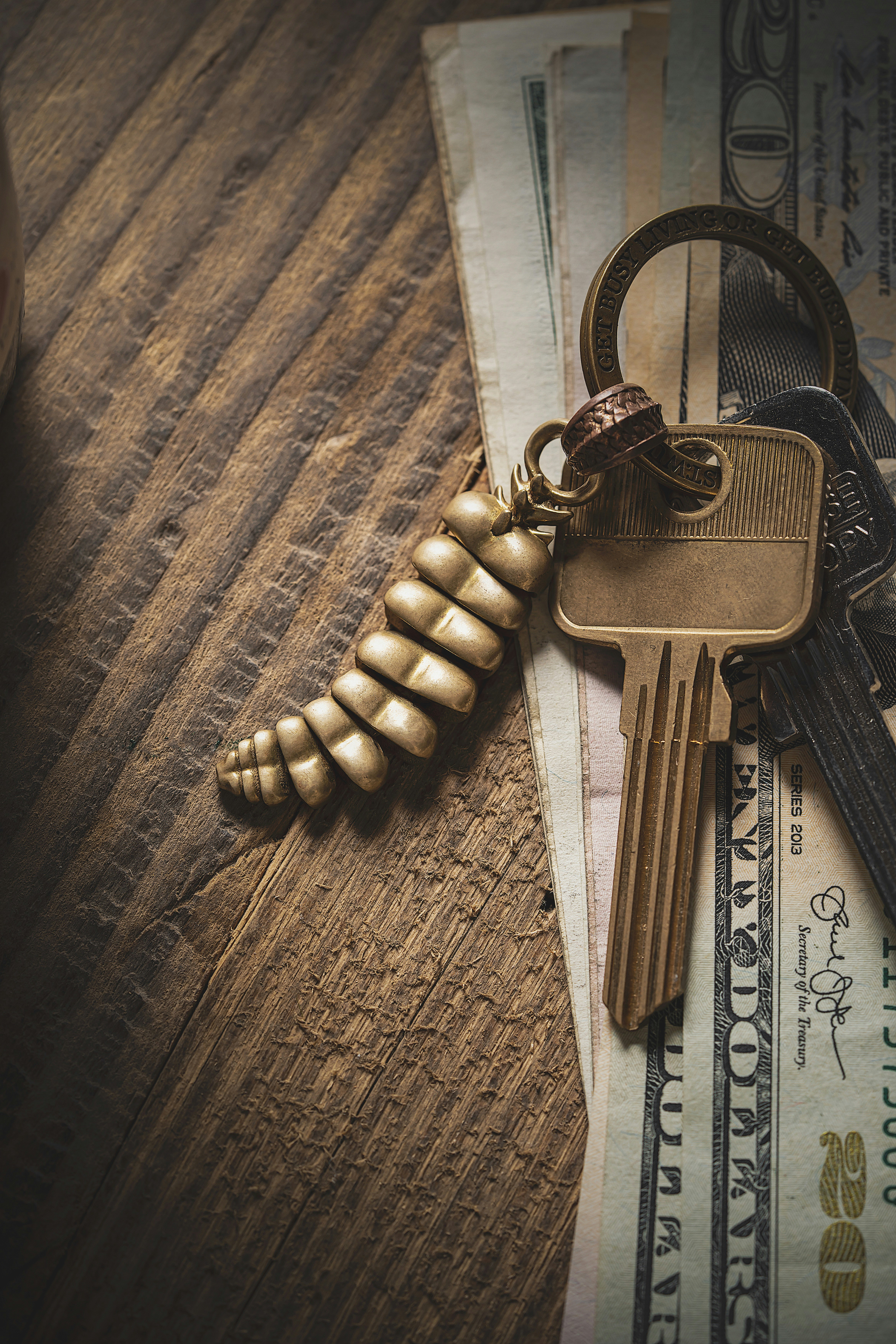 A bunch of keys sitting on top of a pile of money photo – Free Wood ...