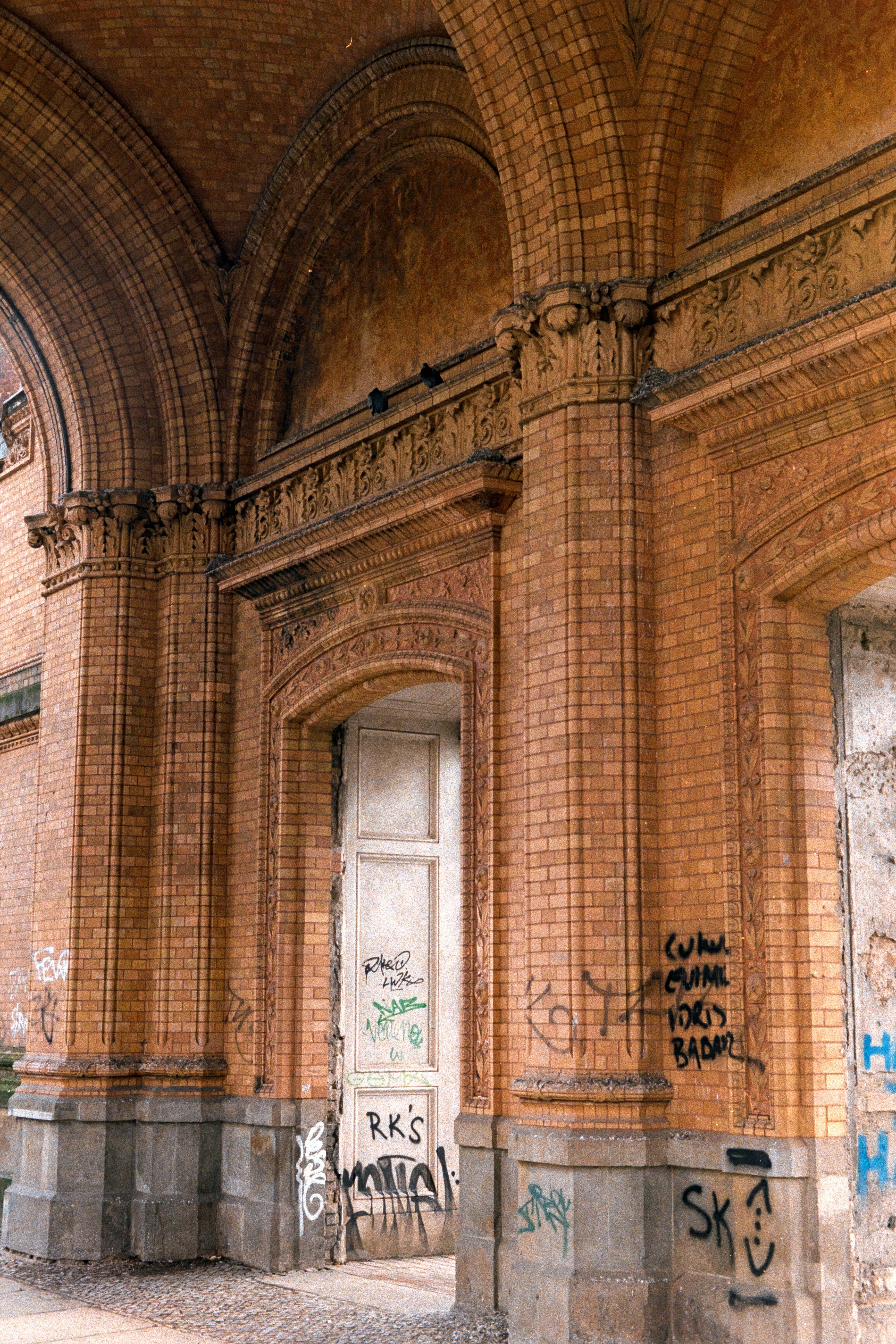 Brick Arches in Graffiti Light: A Quiet Portrait of Time