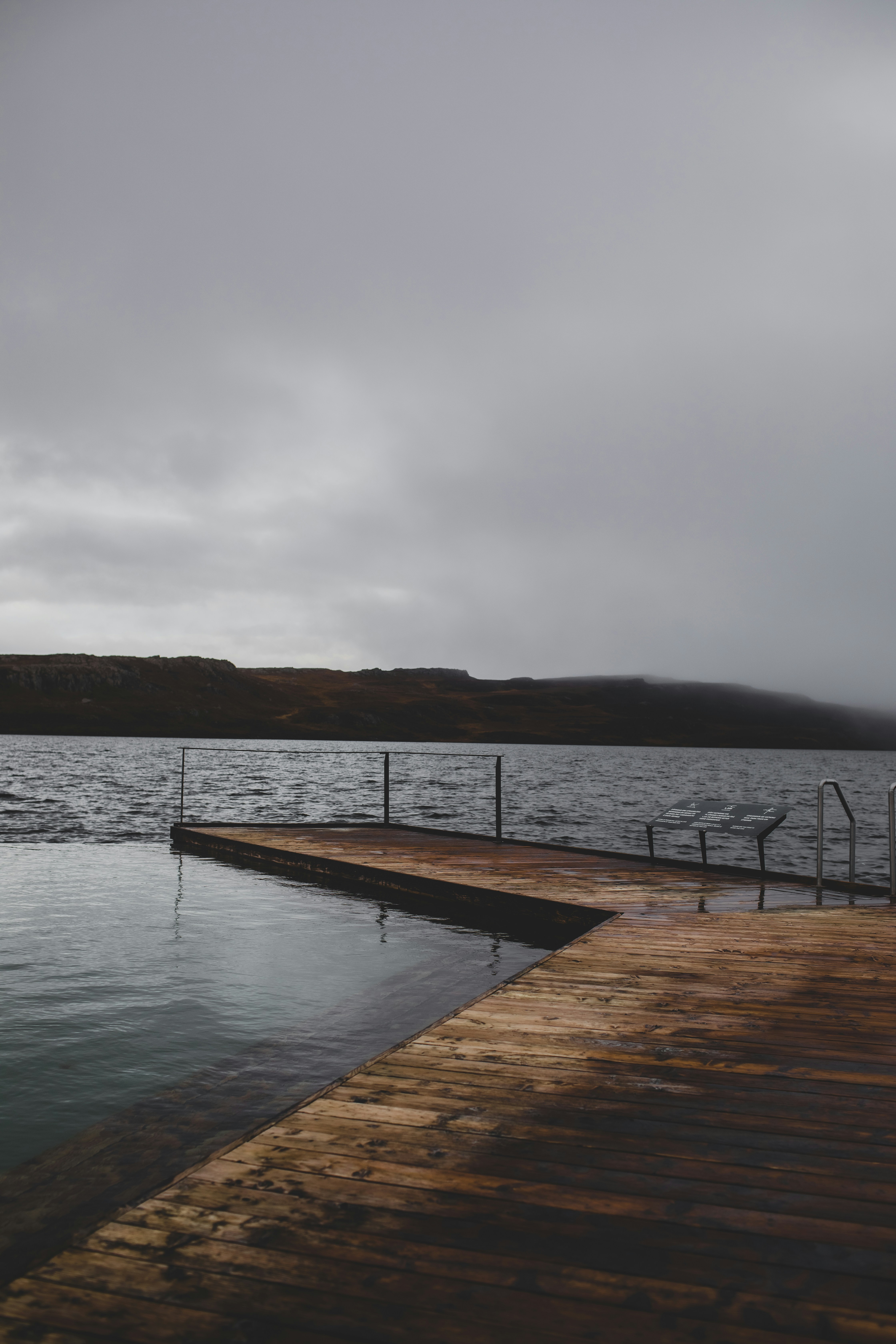 Dawn on the Quiet Dock: Wooden Platforms Meet a Misty Waterfront