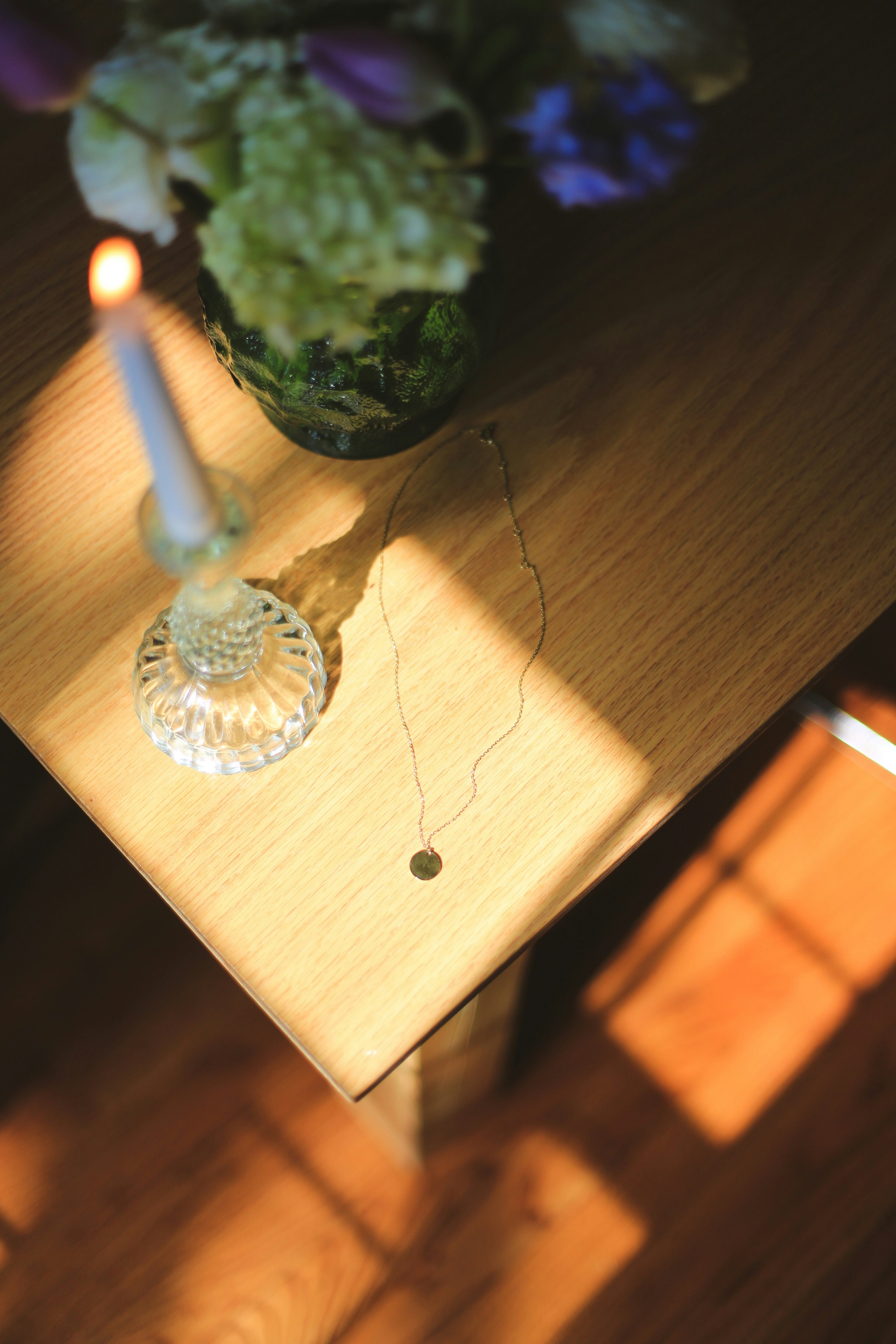 Pendant Gleam on a Warm Oak Desk Beneath Candlelight