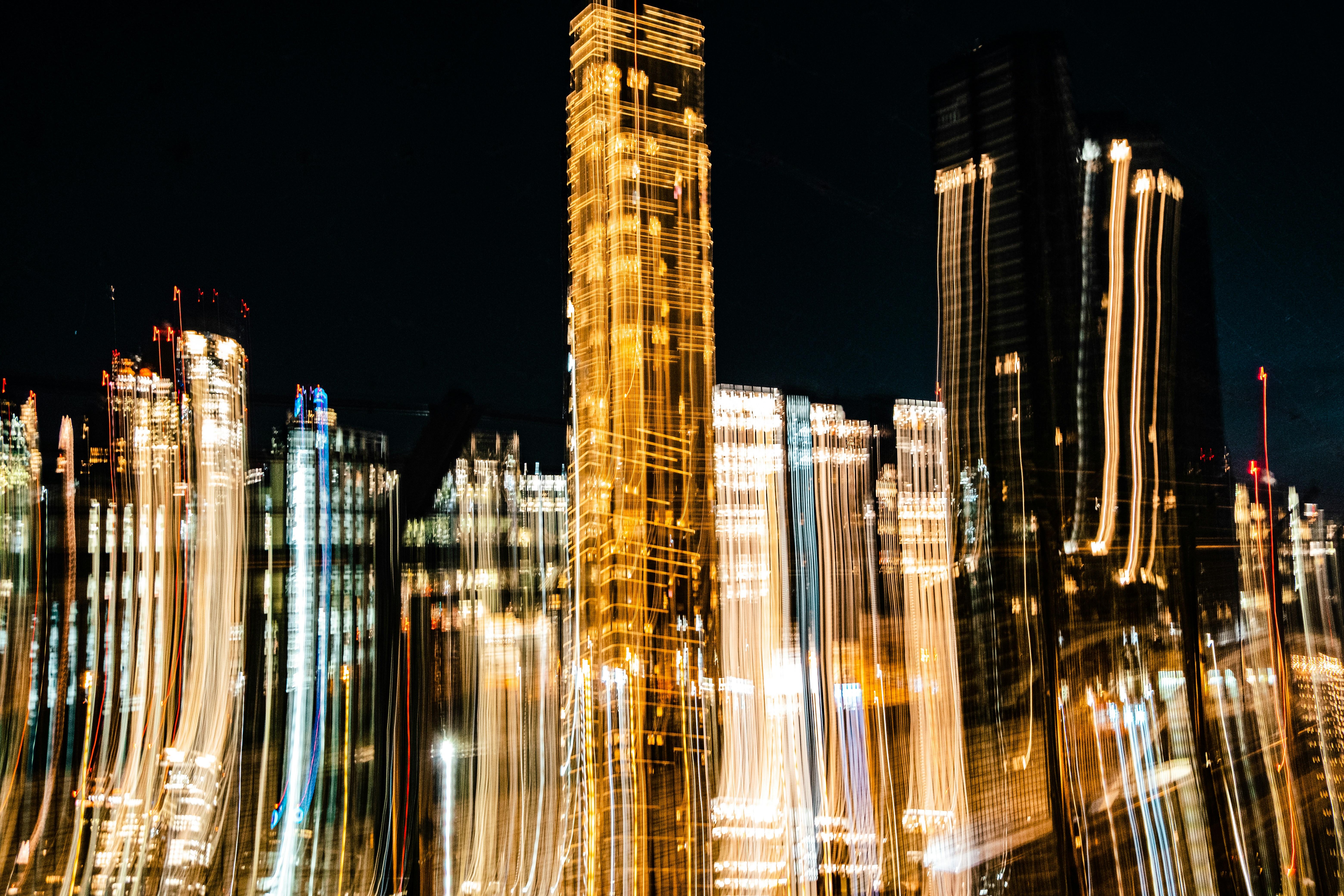 Neon Cascade: Night Skyline Blurred into Golden Streaks
