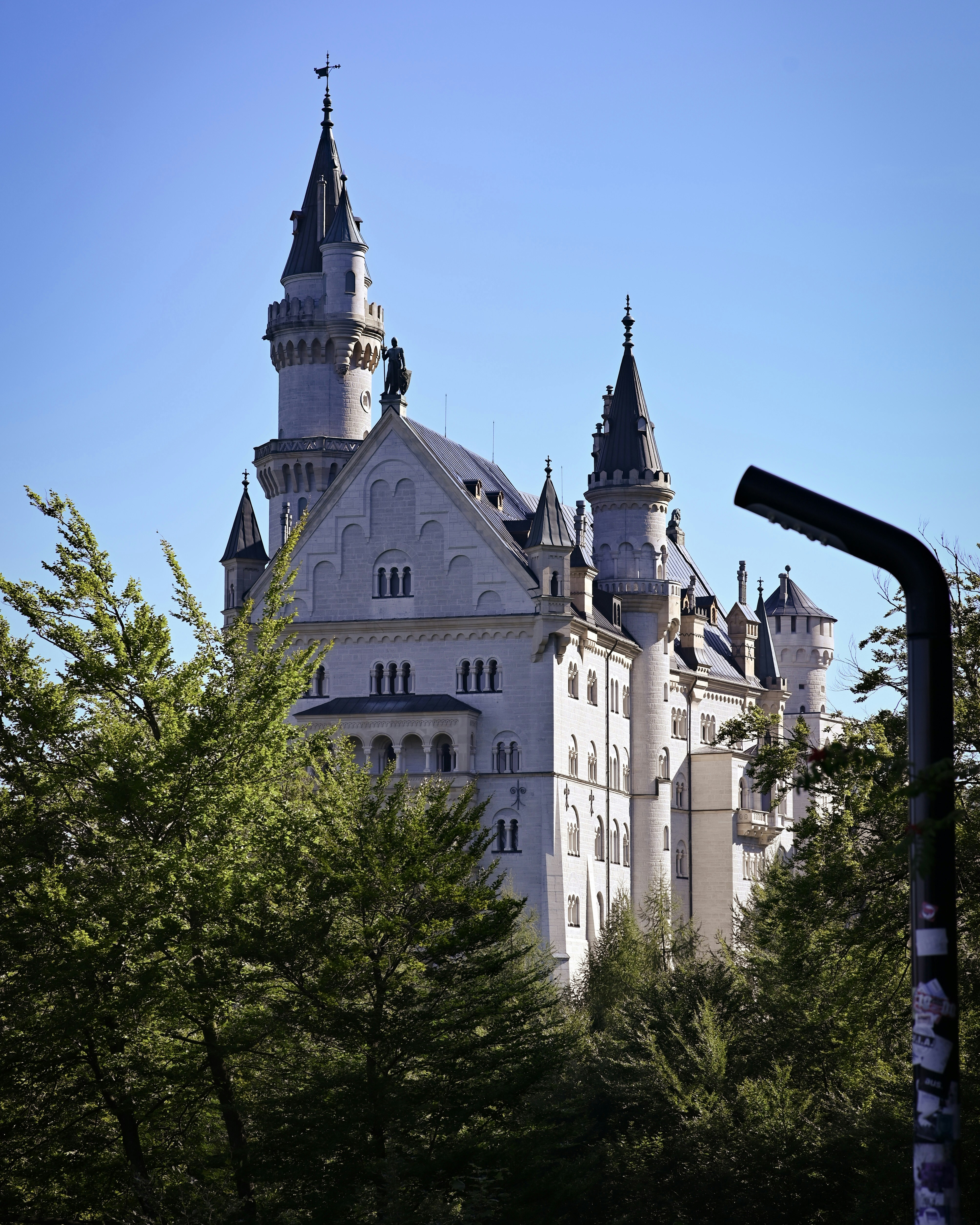 A large white castle with towers surrounded by trees photo – Free ...