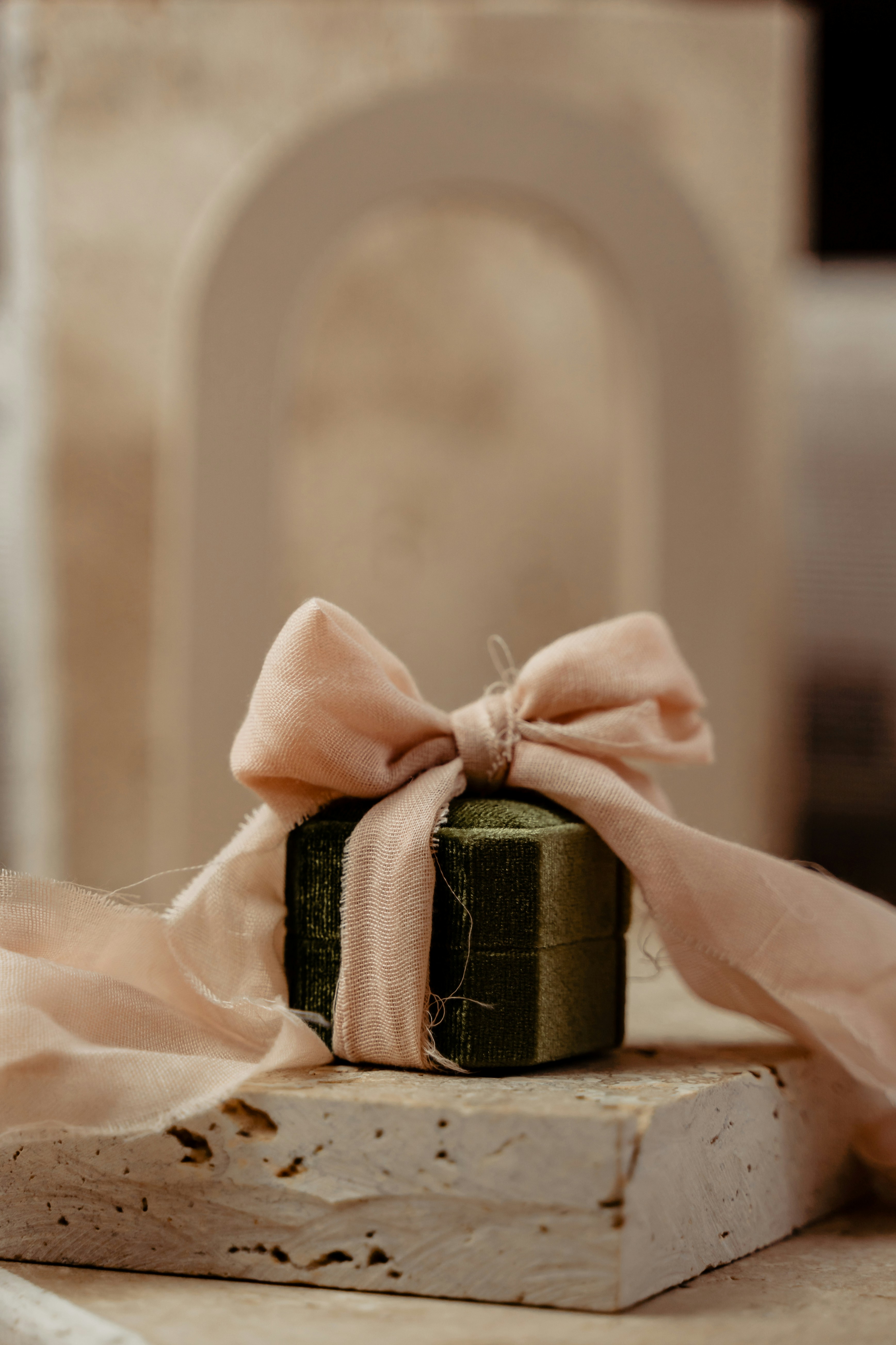 Pastel Bow on a Weathered Pedestal: Quiet Gift Moment