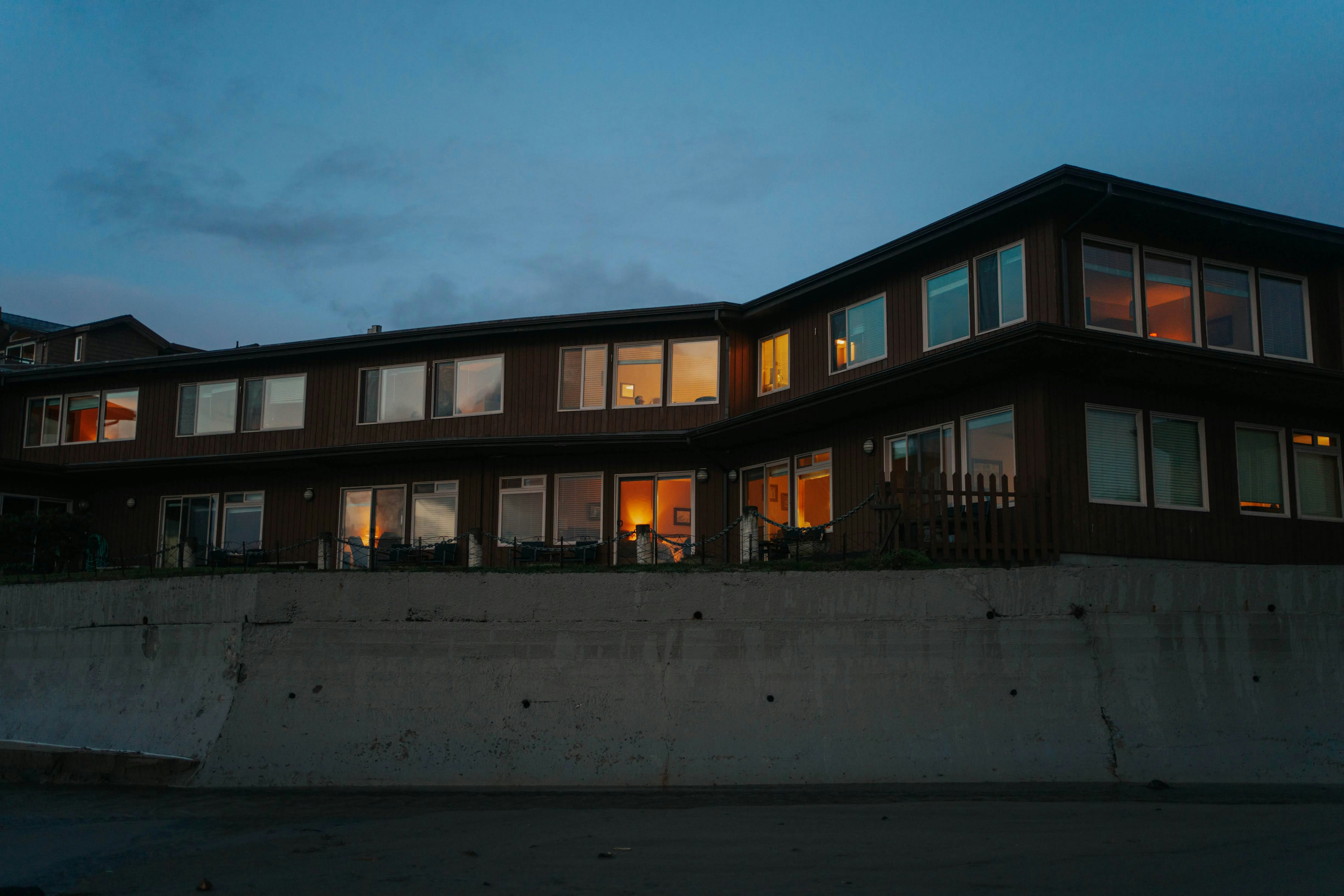 Amber Windows Glow Across a Blue Hour Waterfront Building