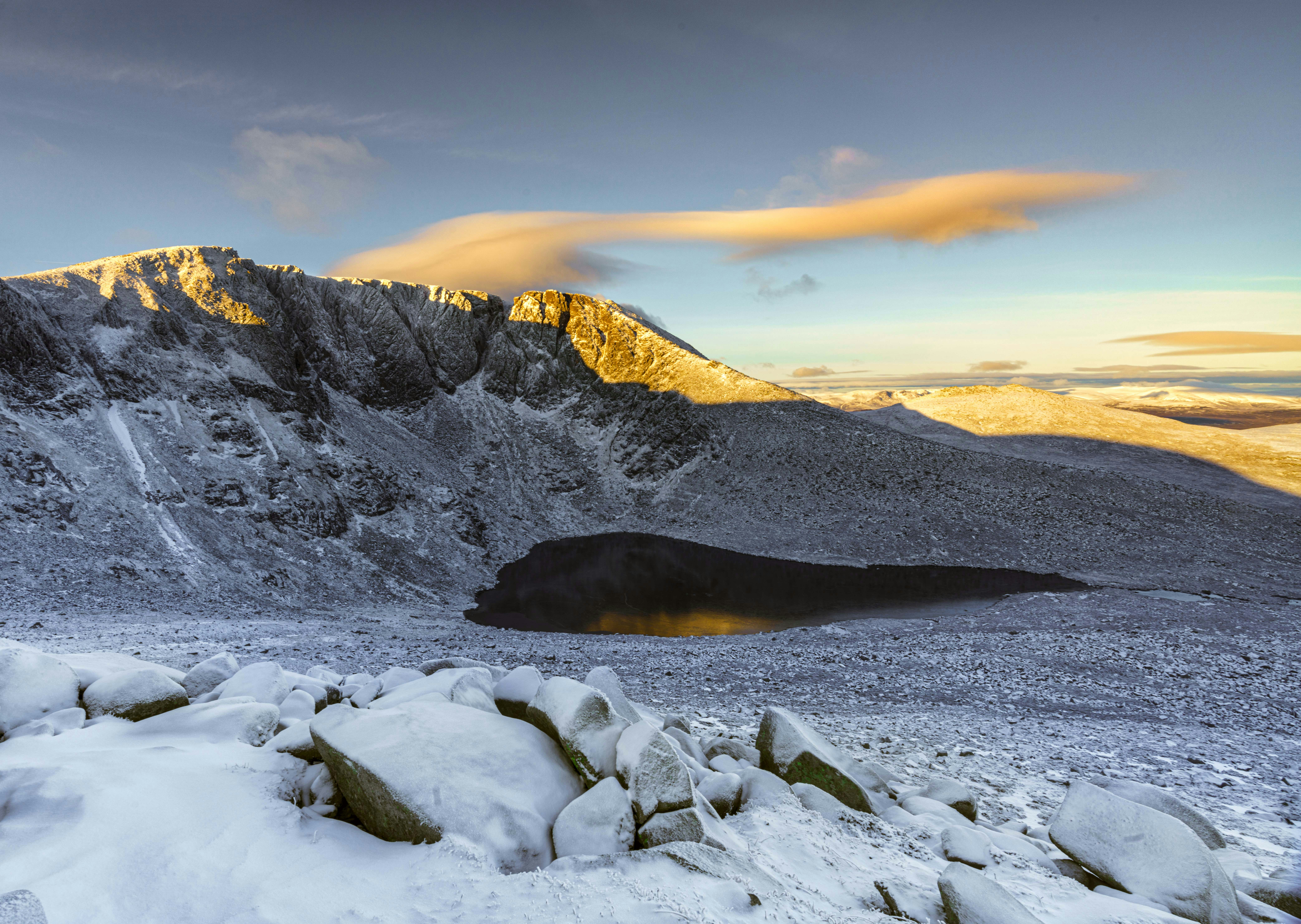 A snow covered mountain with a lake in the foreground photo – Free ...