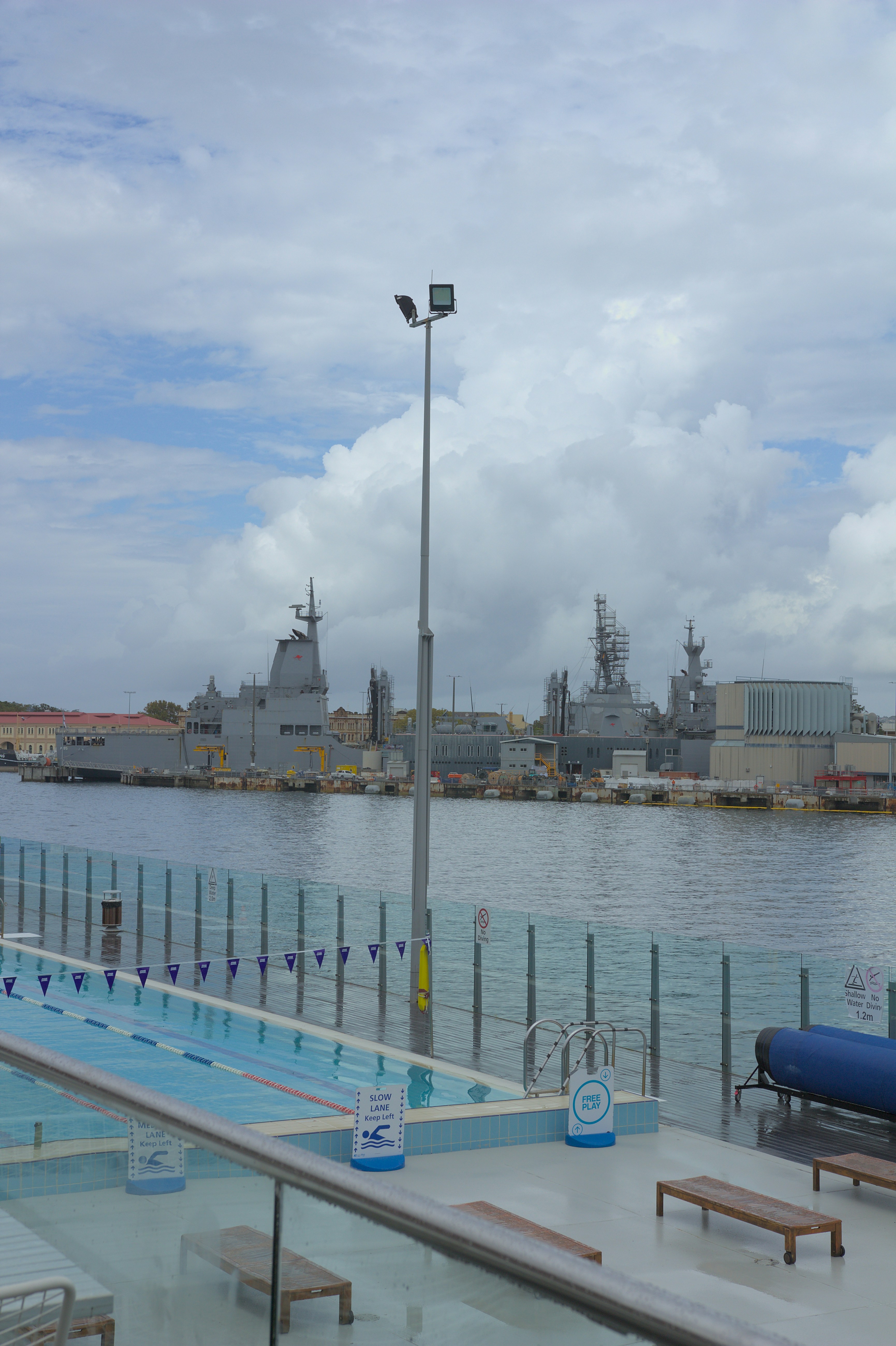 a large body of water with a boat in the background