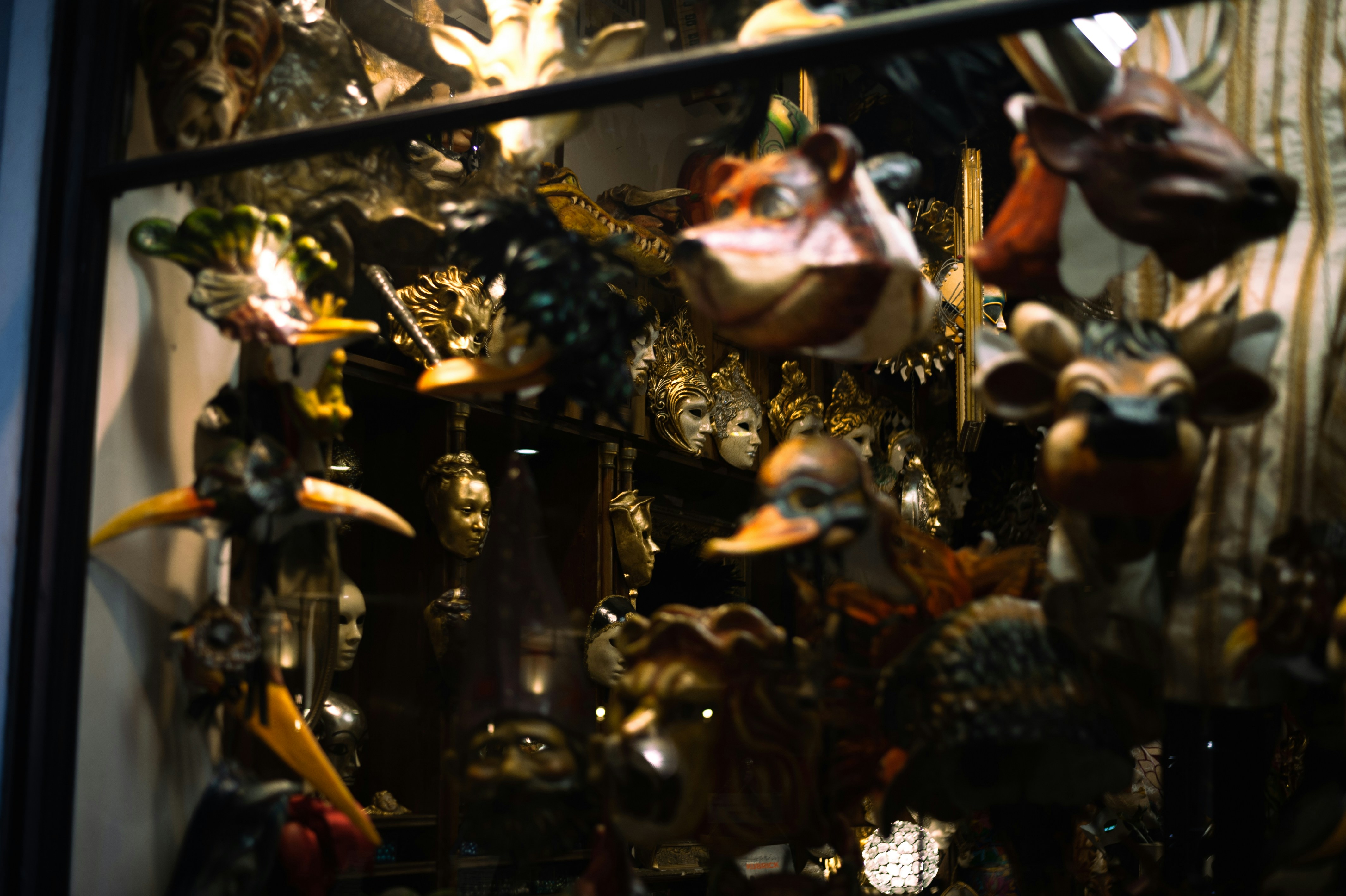 A display case filled with lots of different types of figurines photo ...