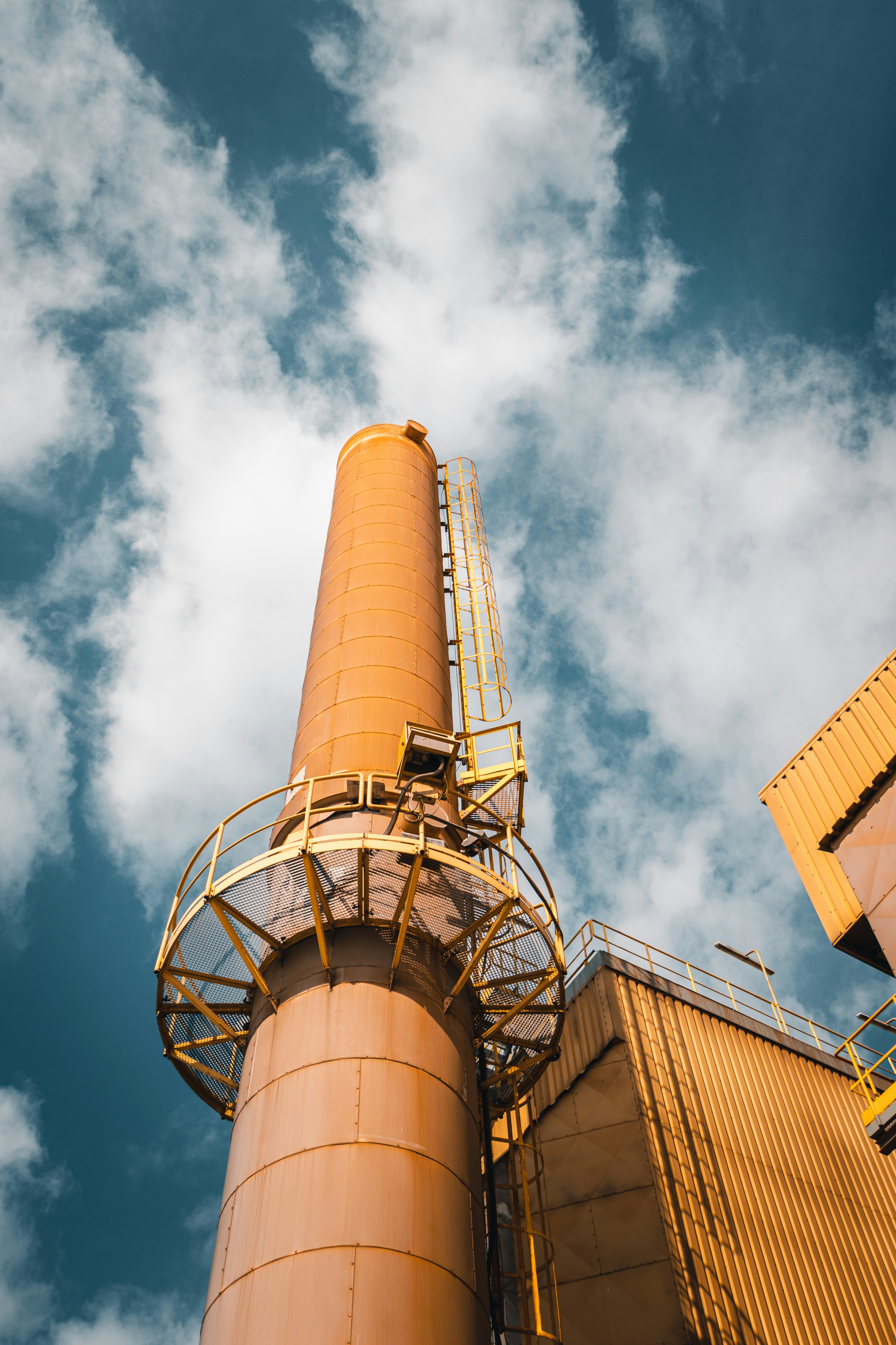 A tall yellow tower with a sky in the background photo – Free Poland ...