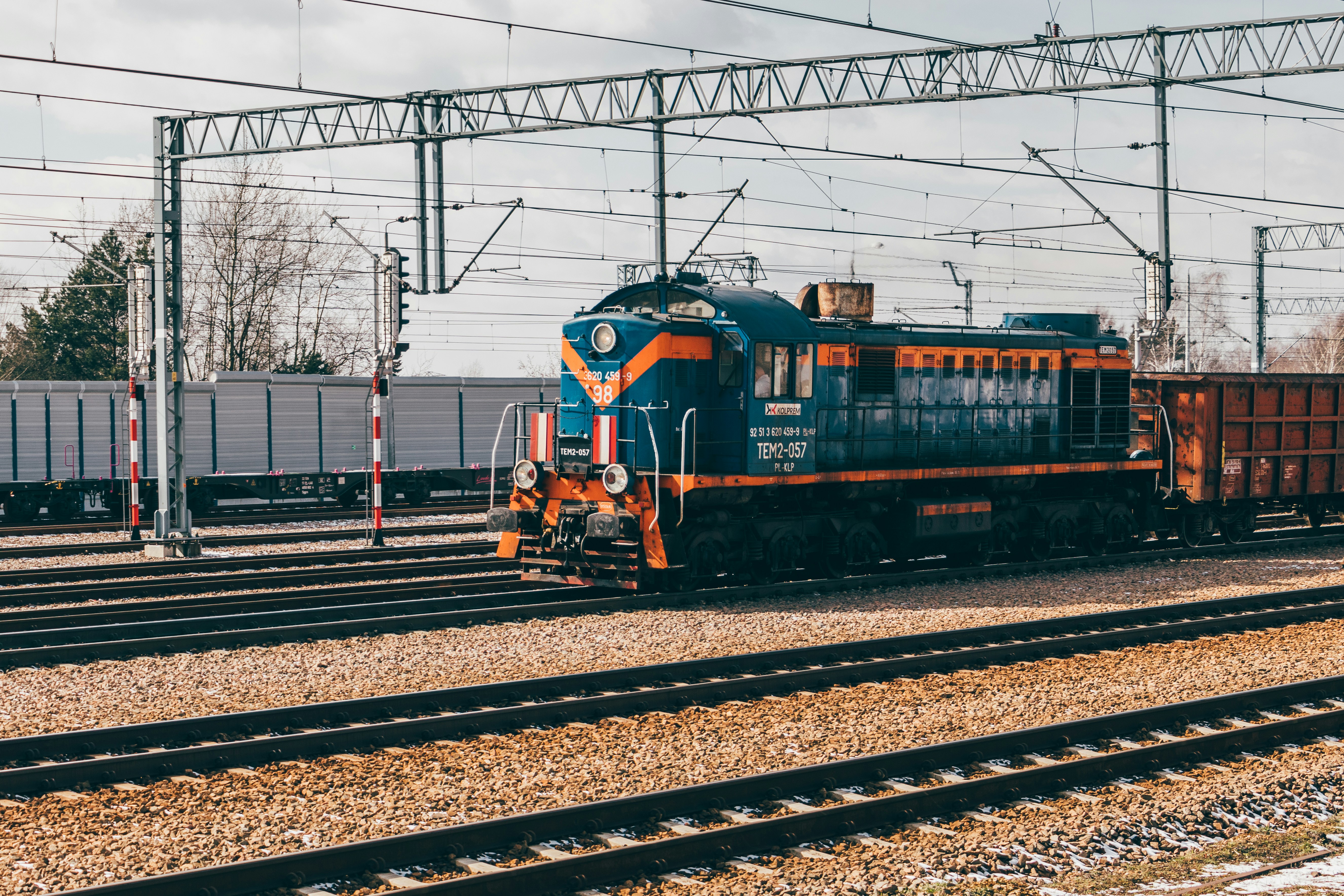A train engine carrying carts down a track photo – Free Poland Image on ...