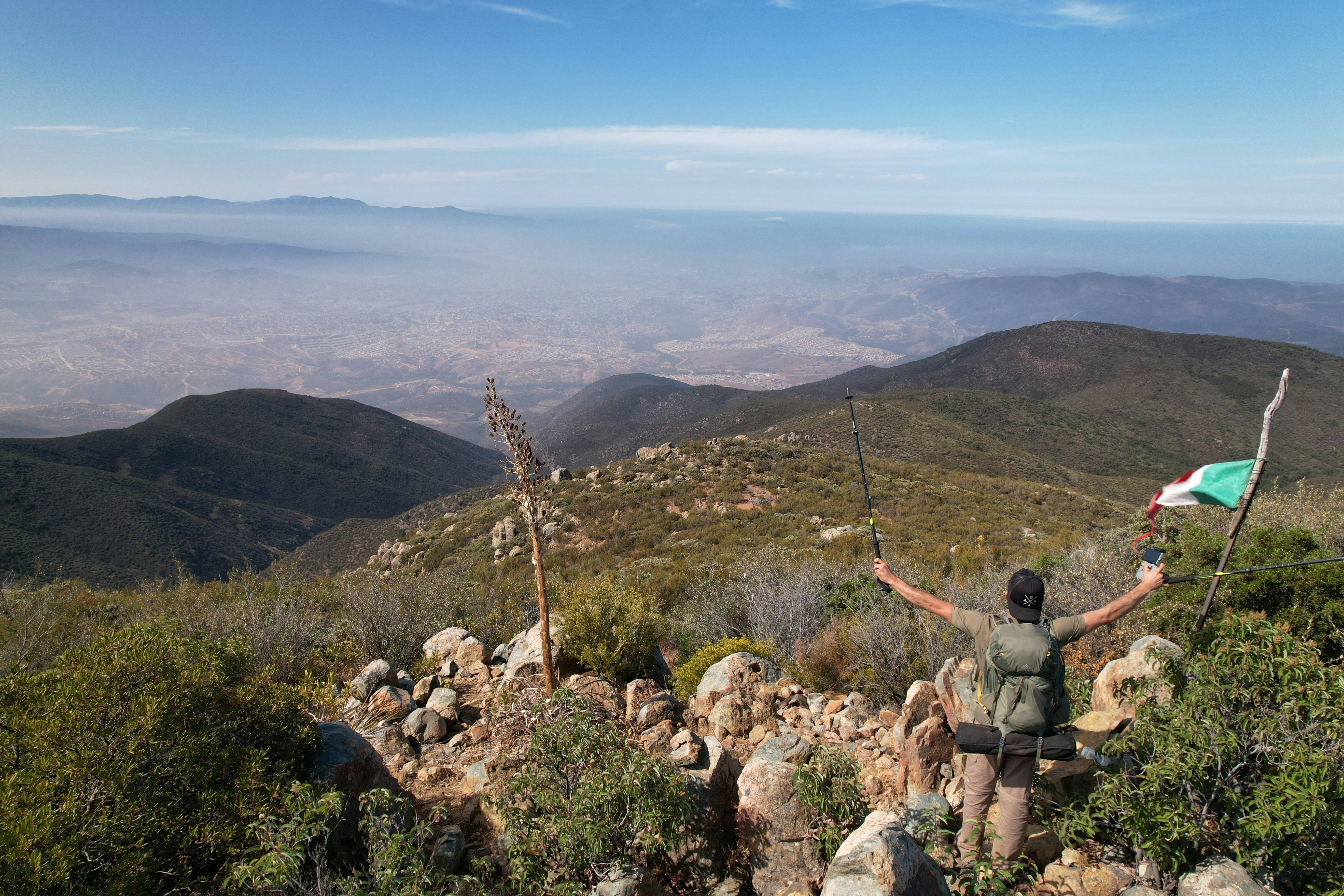Summit Triumph: A Hiker's Victory Over the Horizon