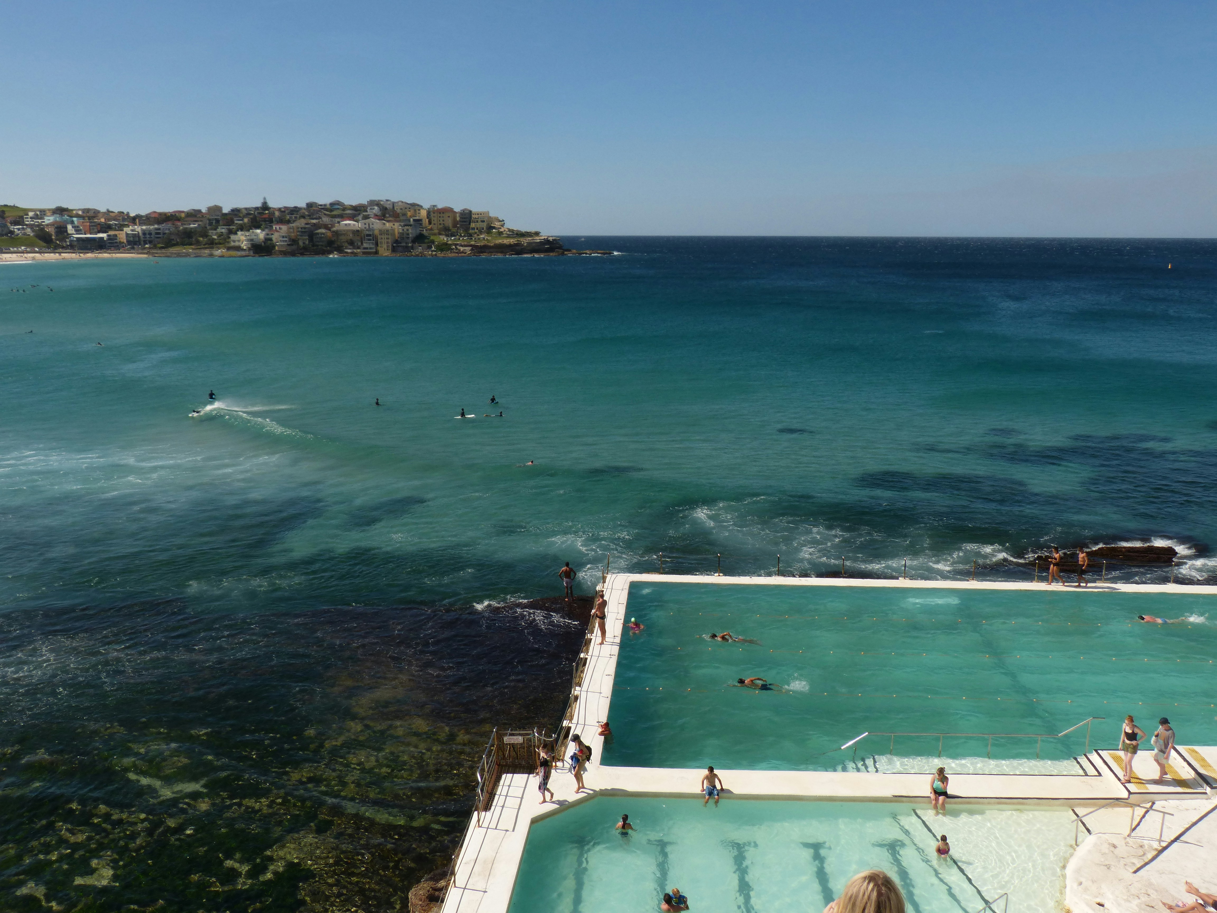 Coastal Poolside Vista: Turquoise Waters and Cliffside Town
