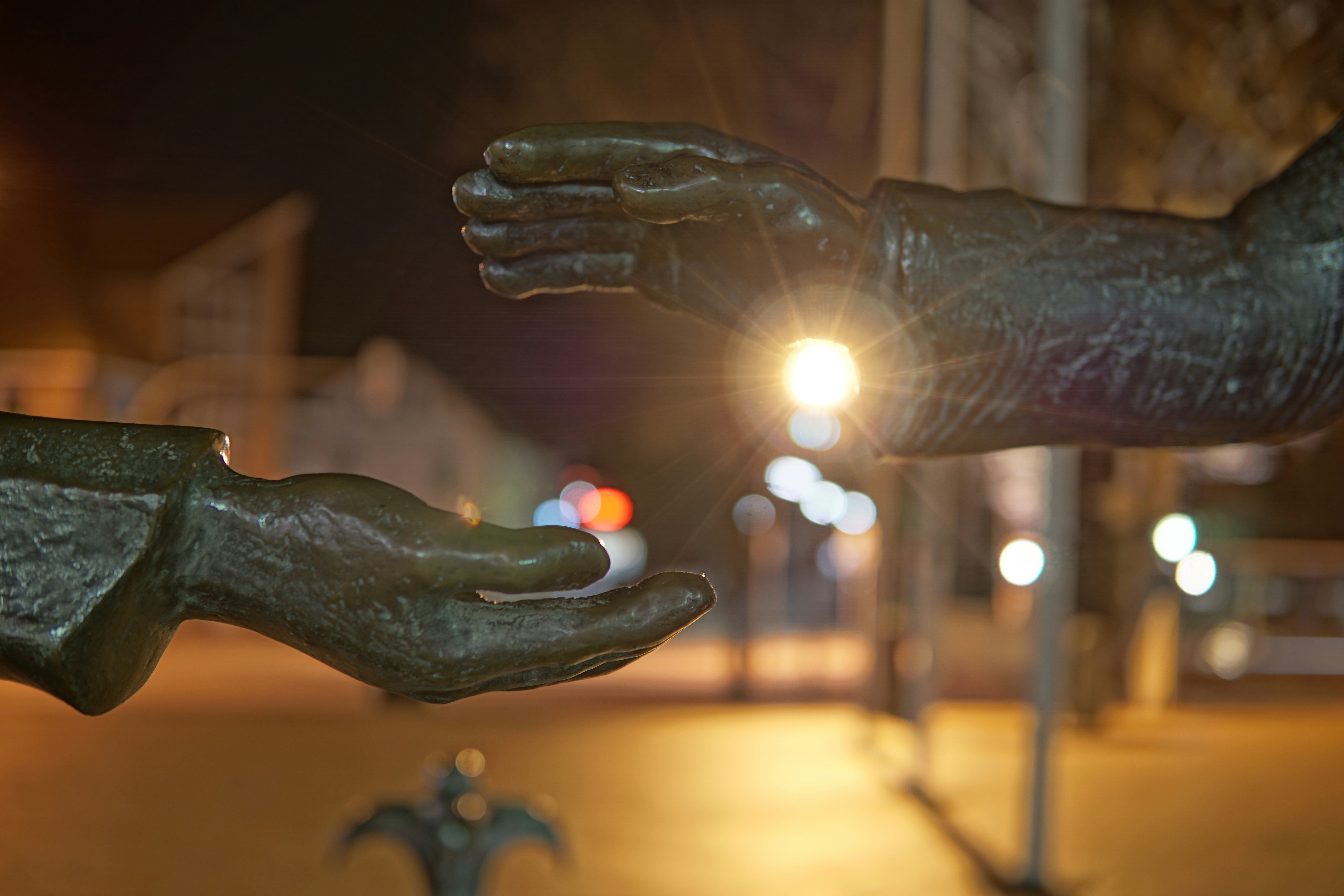 A statue of two hands reaching out towards each other photo – Free ...