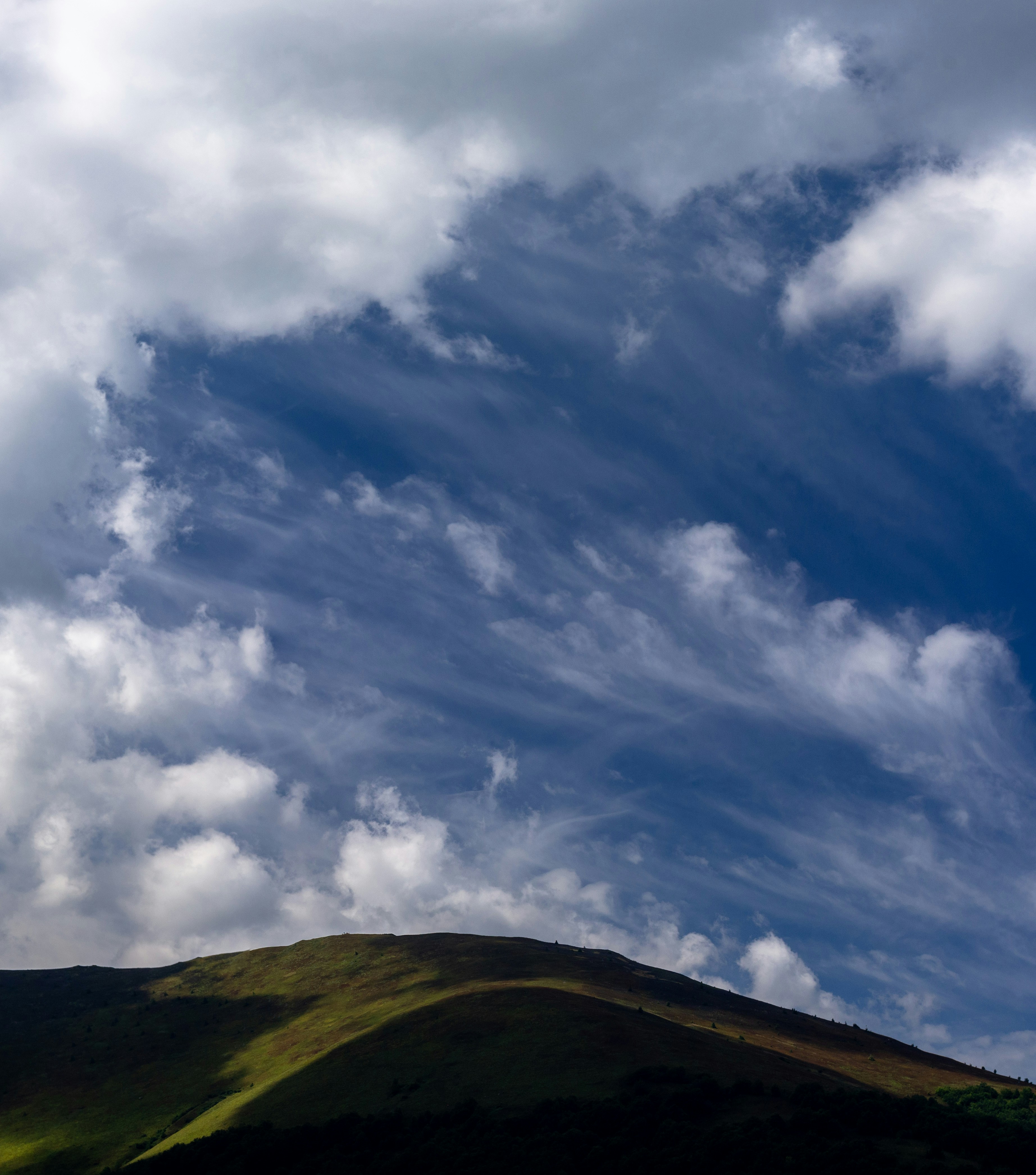 A large hill with some clouds in the sky photo – Free Cloud Image on ...