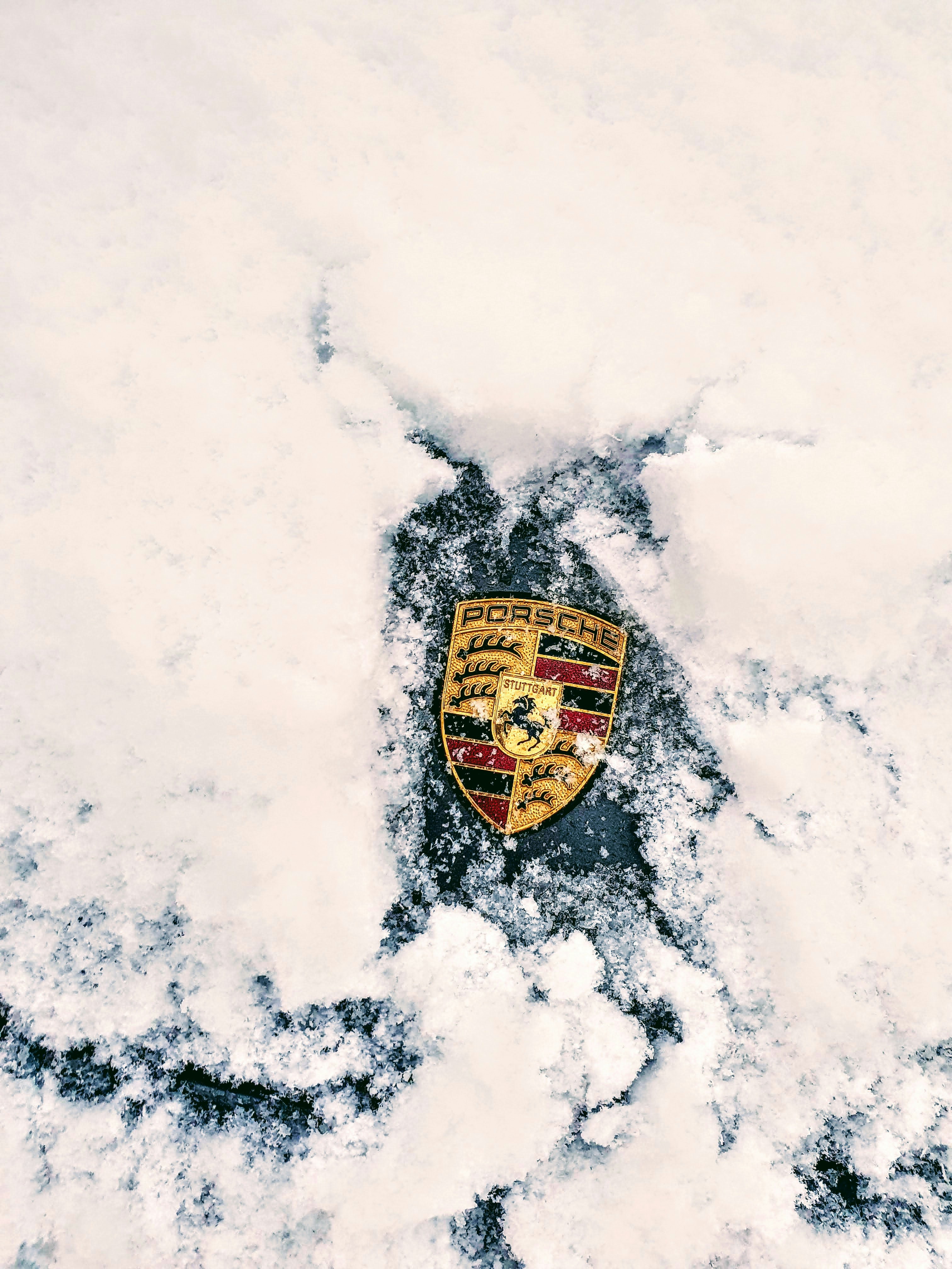 a porsche emblem is seen in the snow