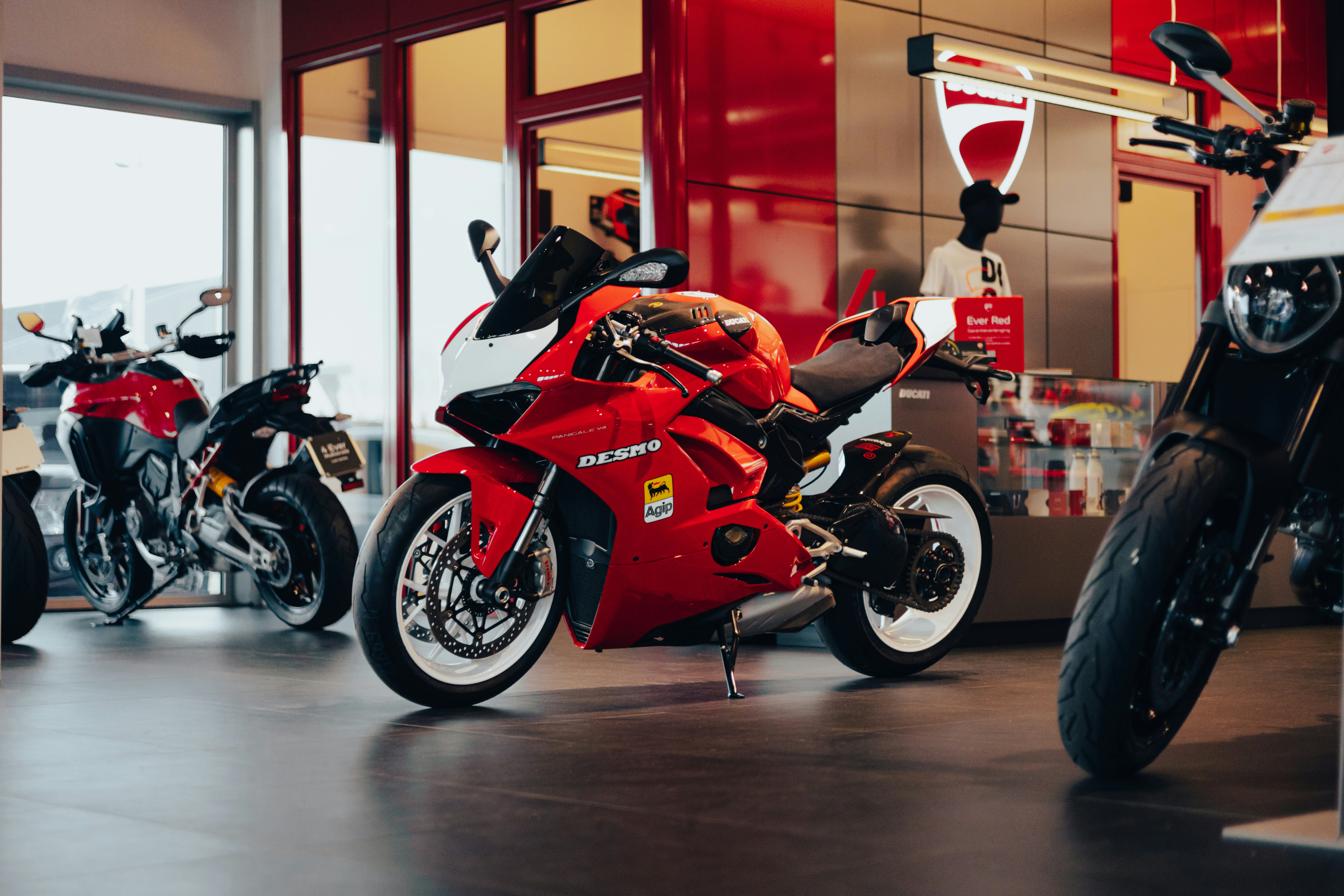 A group of motorcycles parked inside of a building photo – Free ...