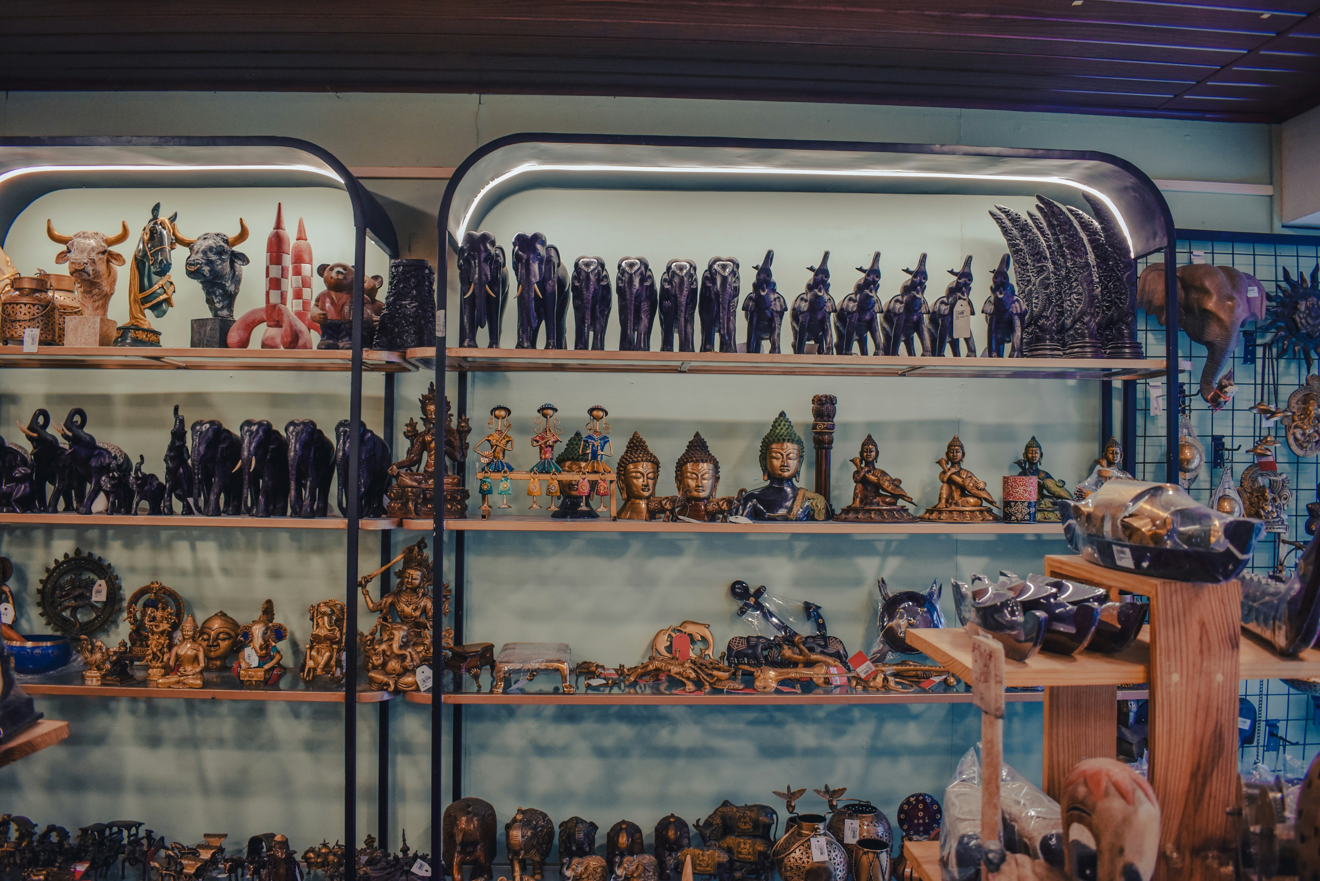 A display case filled with lots of different types of figurines photo ...