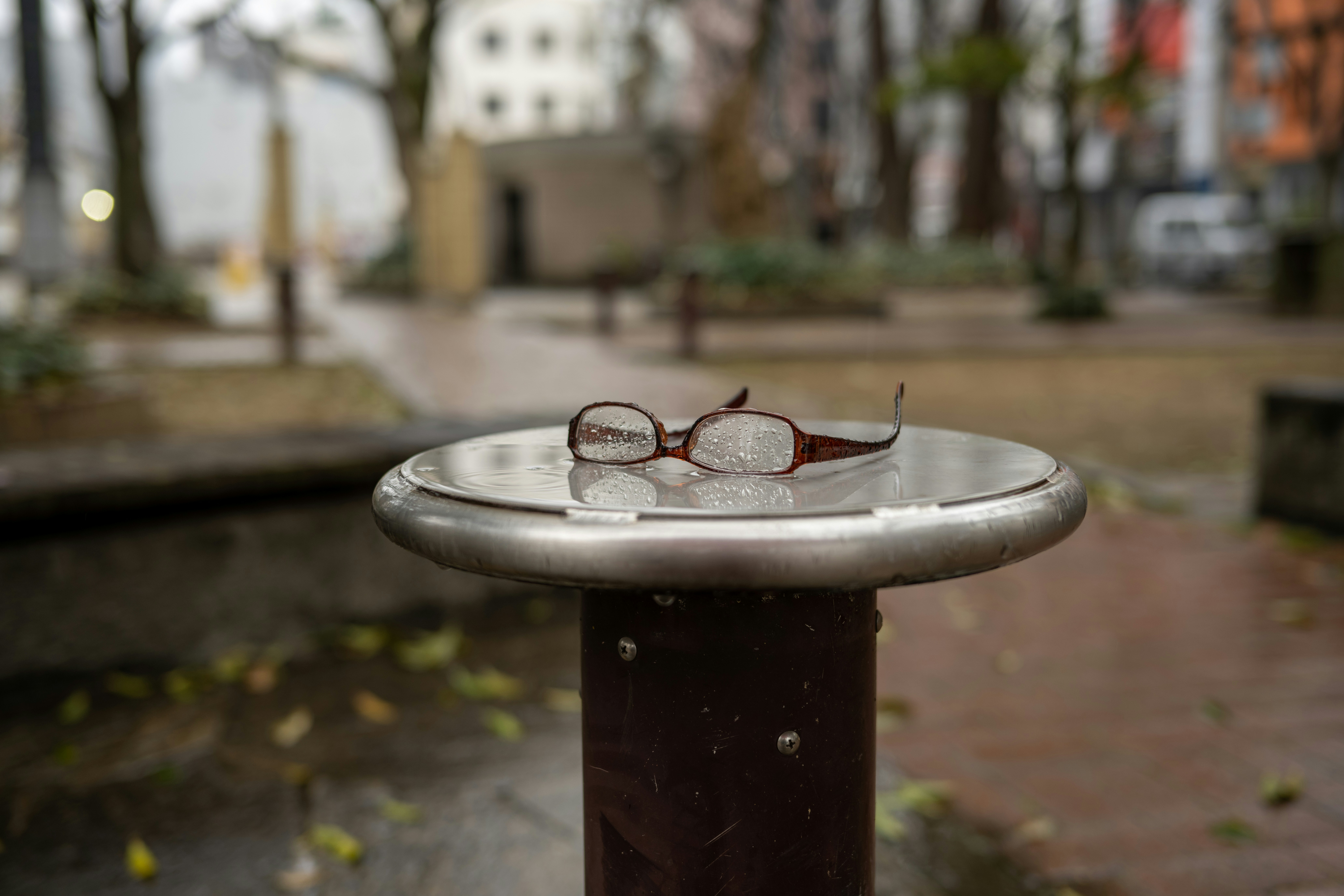 a pair of glasses sitting on top of a metal table