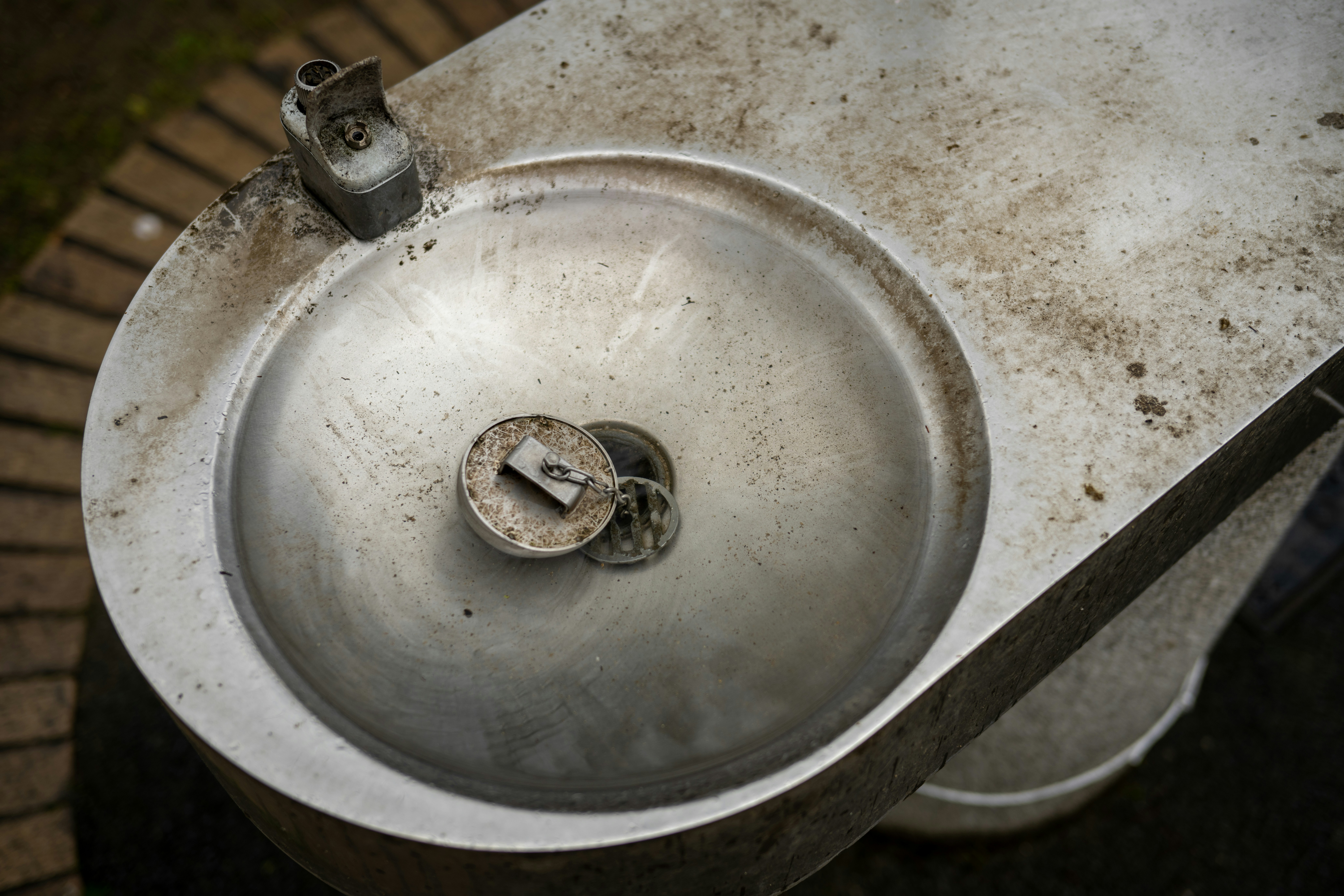 a metal sink with a lock on the side of it