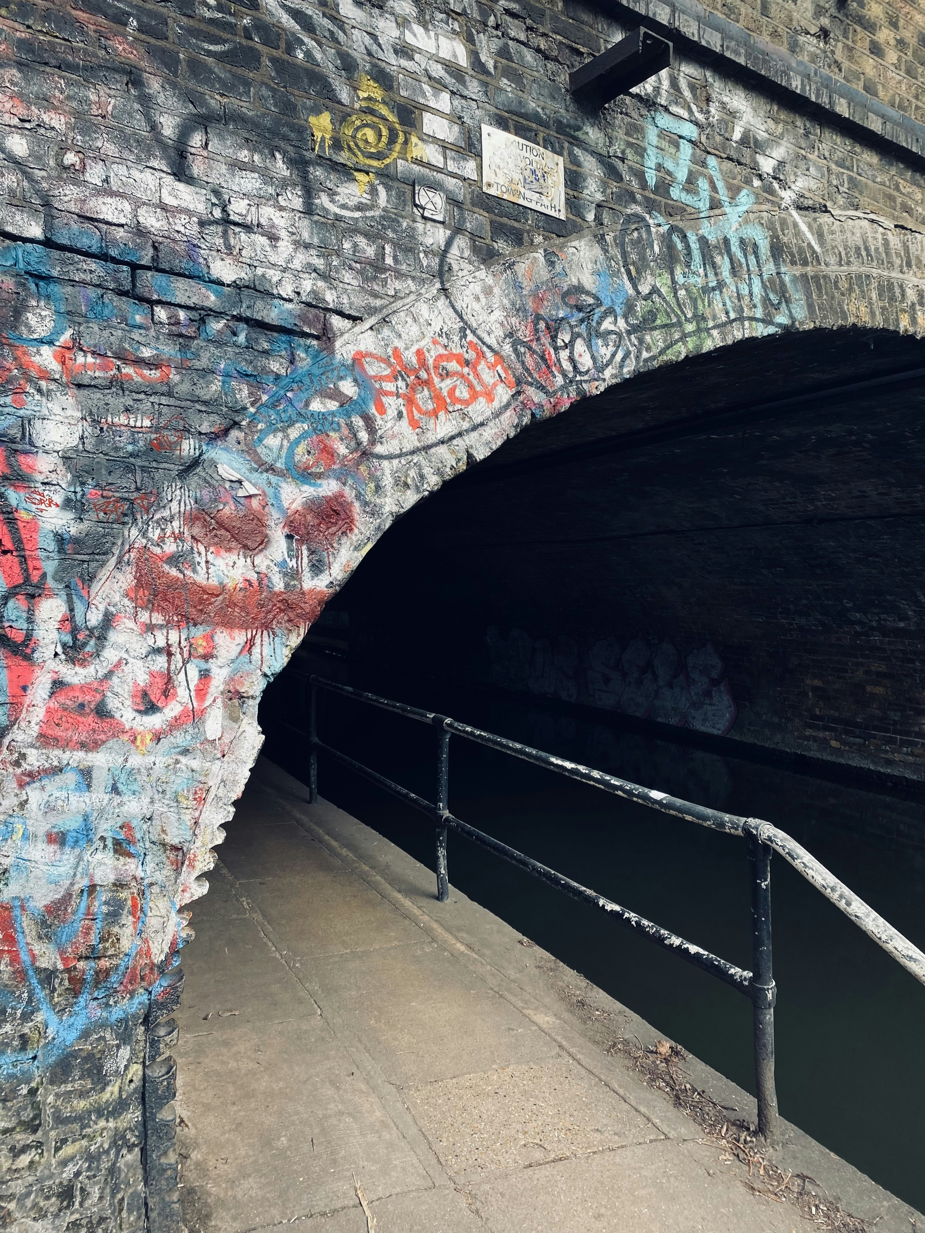 A bridge with graffiti on it and a railing photo – Free London canal ...