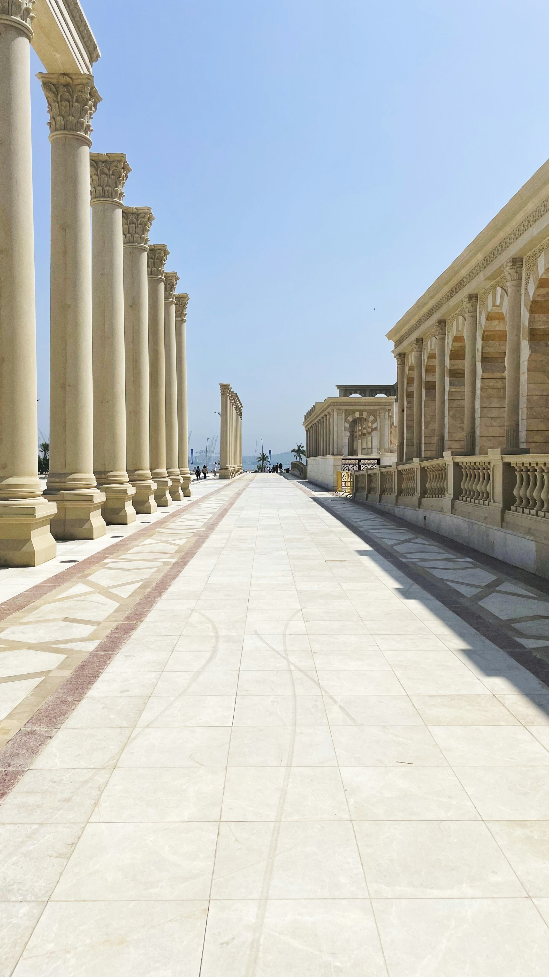 Horizon Through Stone: A Sunlit Colonnade by the Sea