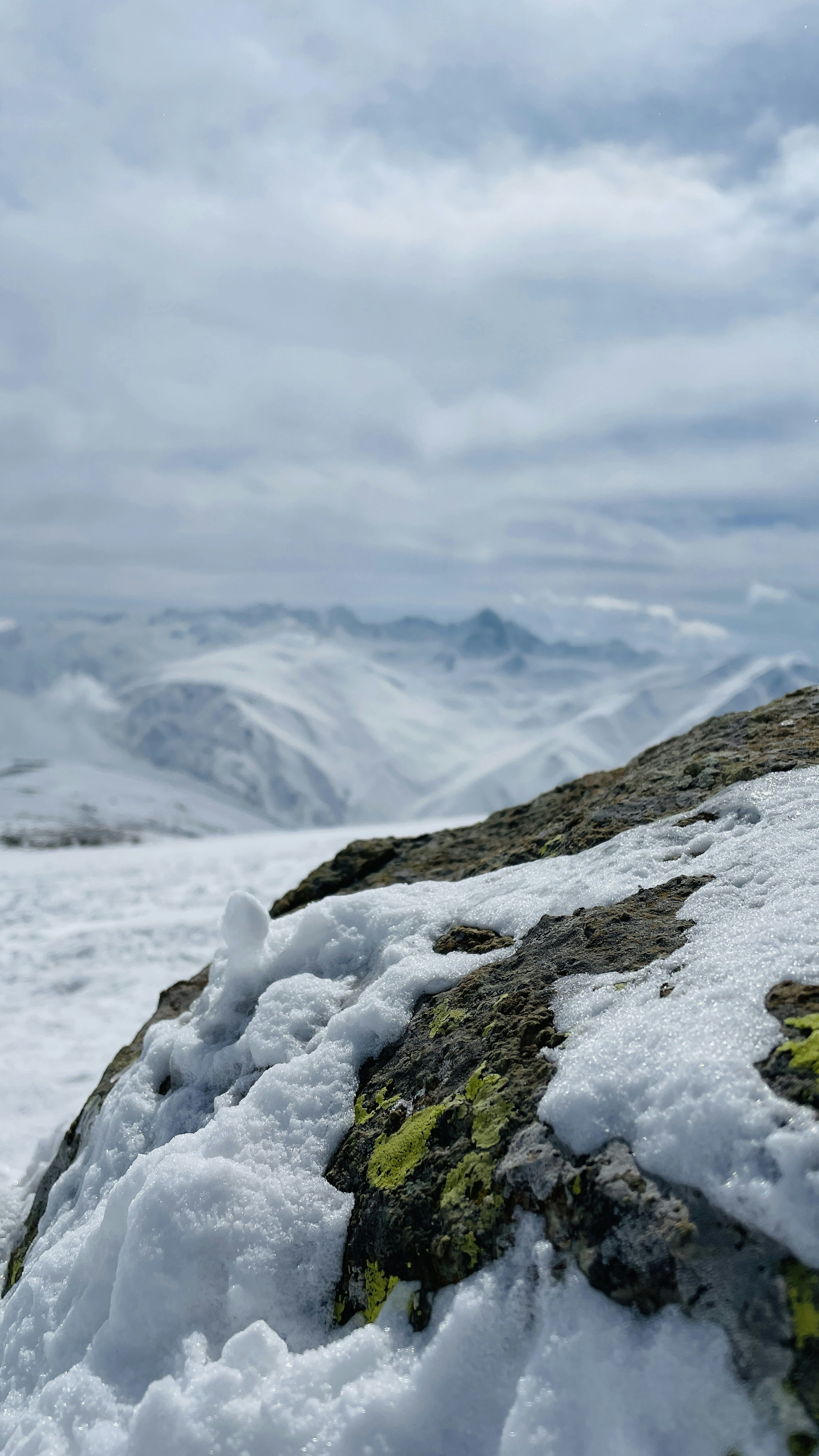 A rock covered in snow on top of a mountain photo – Free Travelling ...