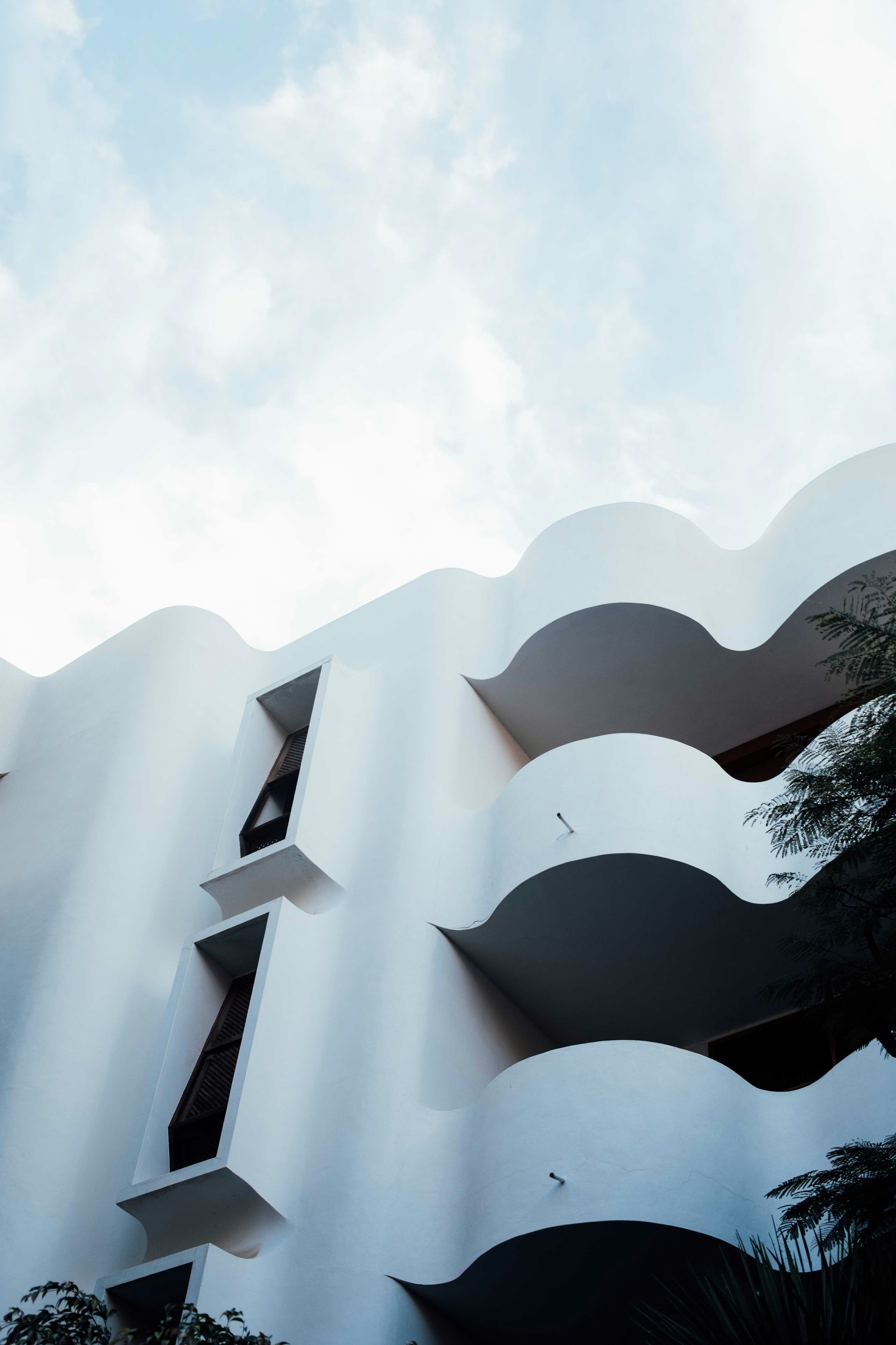 Aquatic Waves of Architecture: A Sea of Curves on White Facade