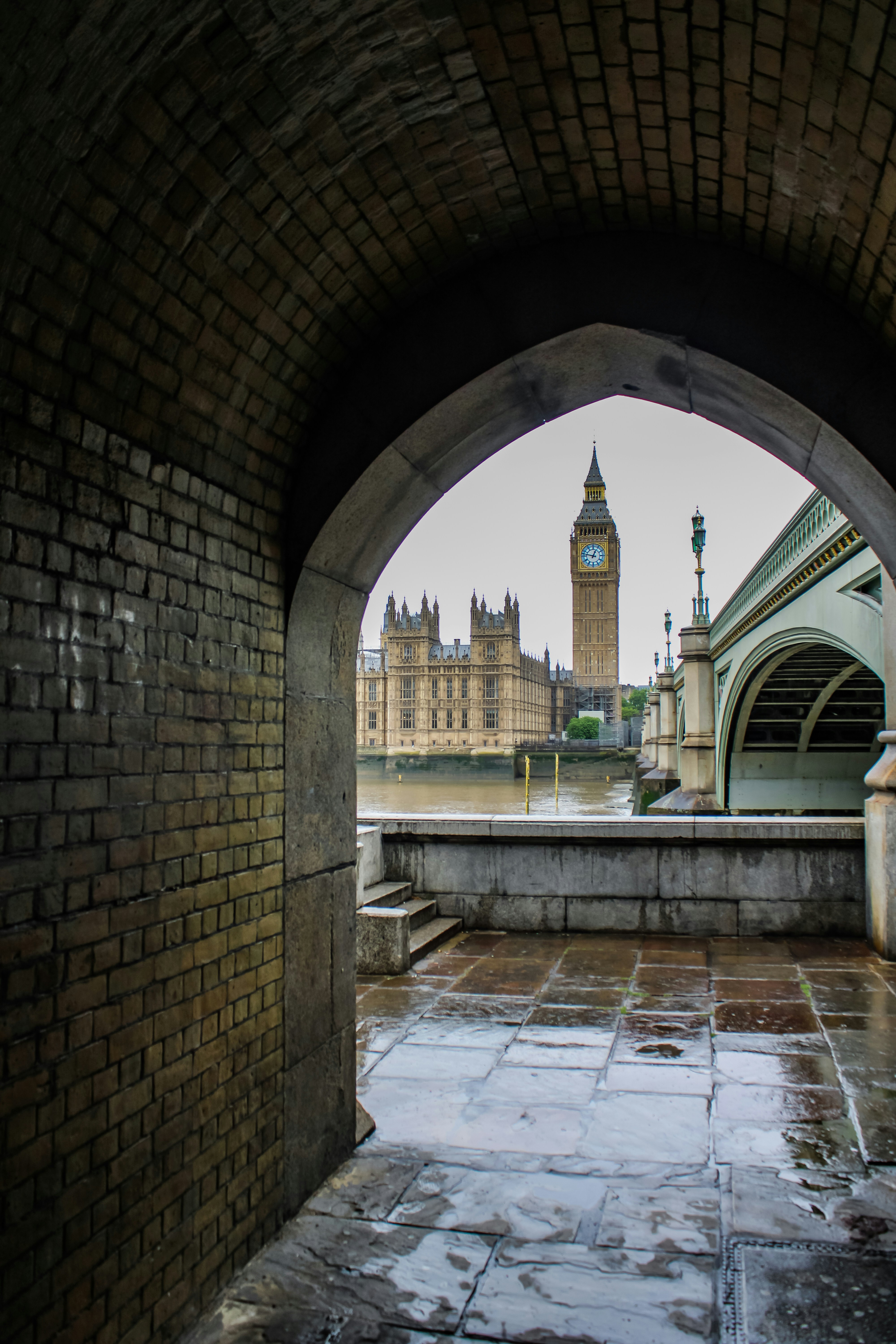 A view of the big ben clock tower through an archway photo – Free Path ...