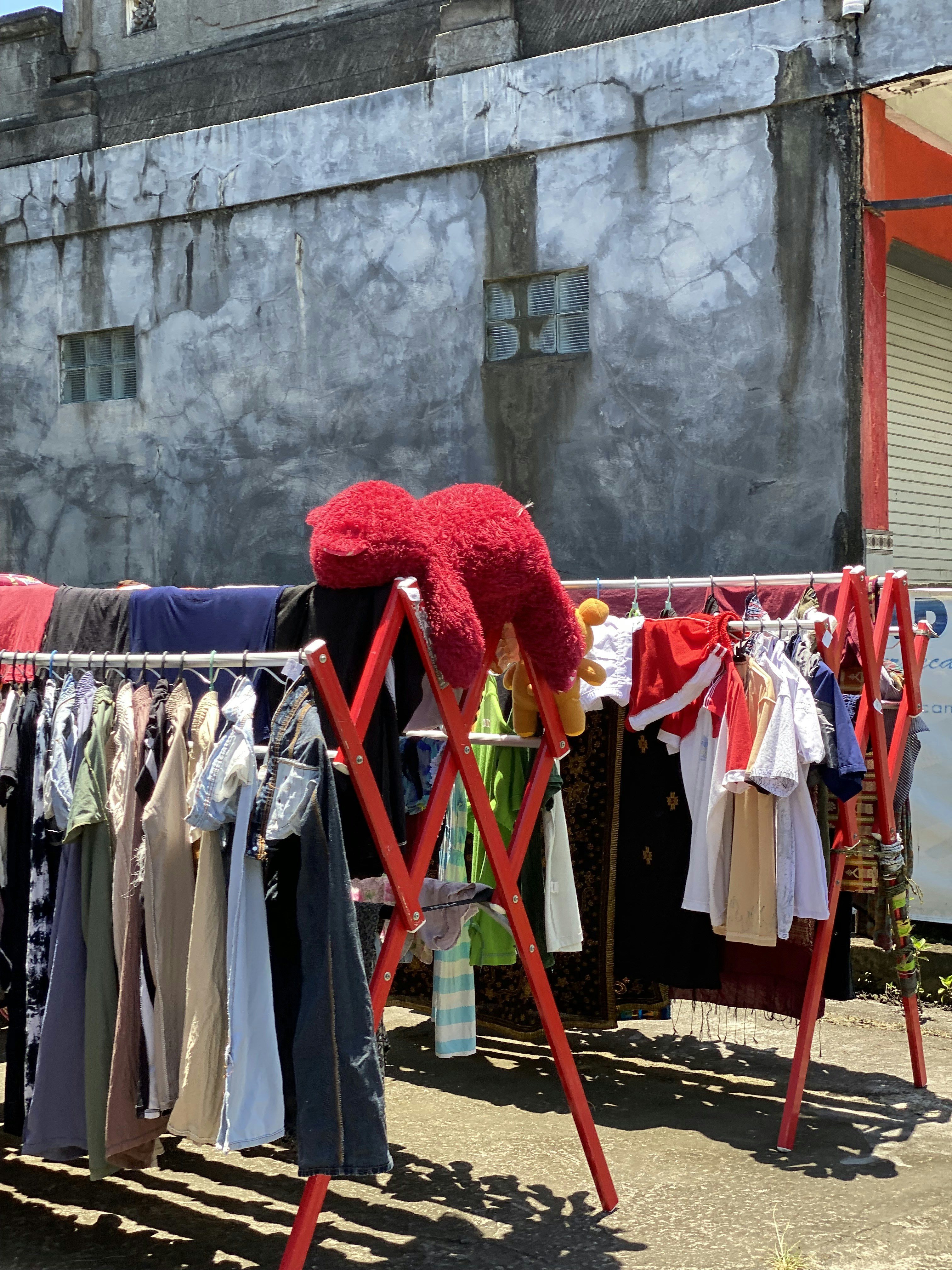 Red-Frame Laundry Lines Under Industrial Wall
