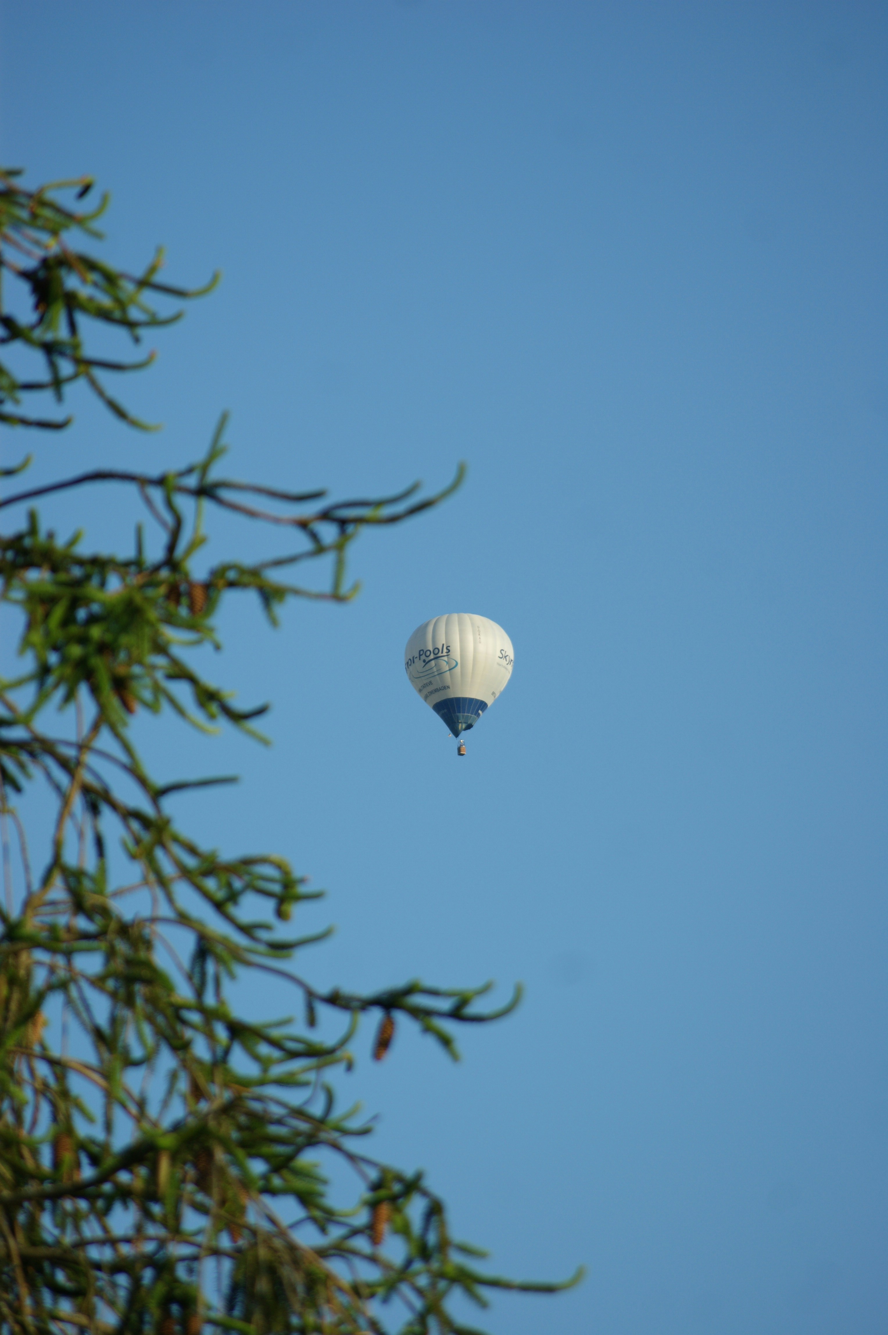 a hot air balloon flying through a blue sky