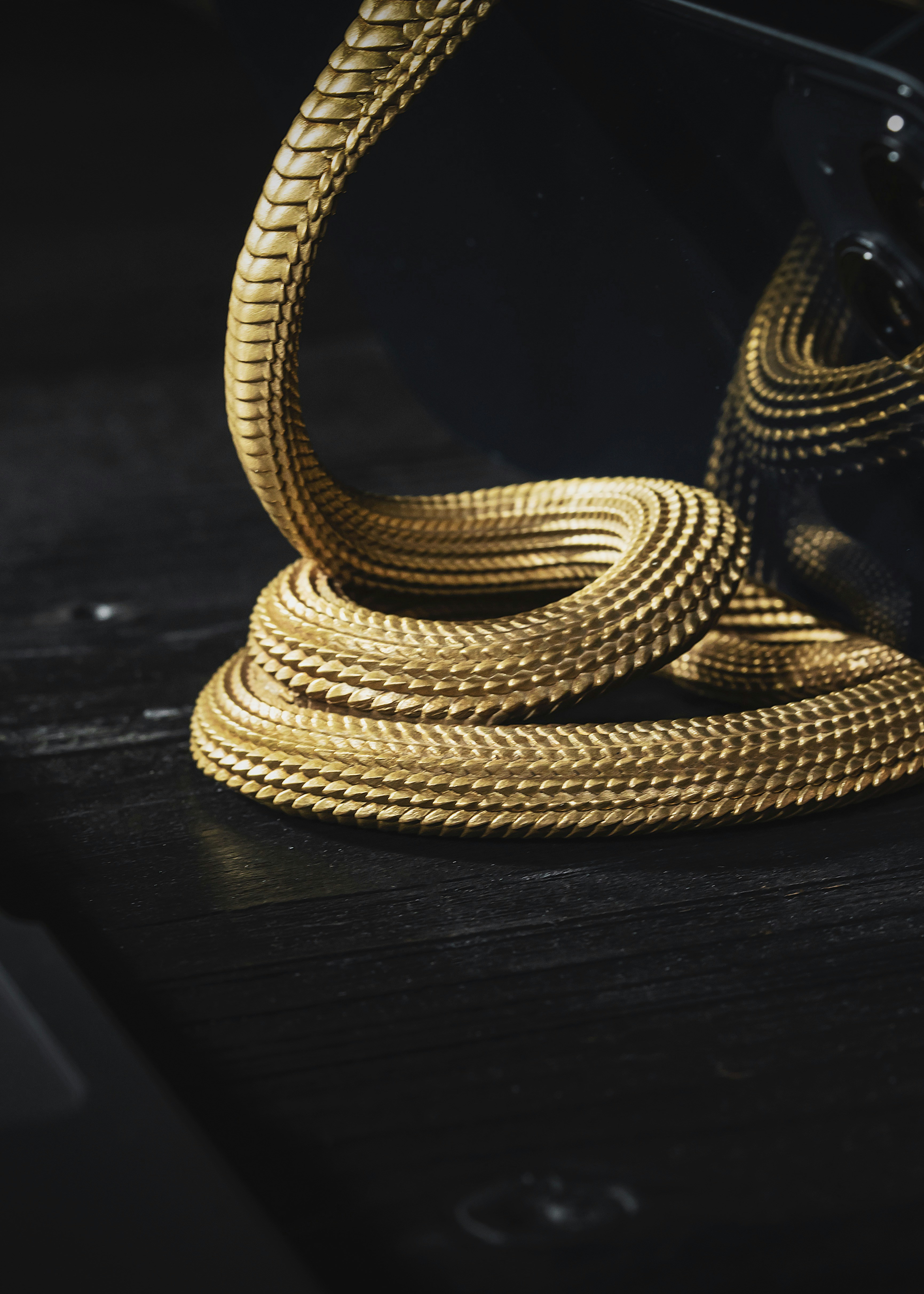 Golden Coil: A Close-Up of Metallic Weave on a Leather Surface