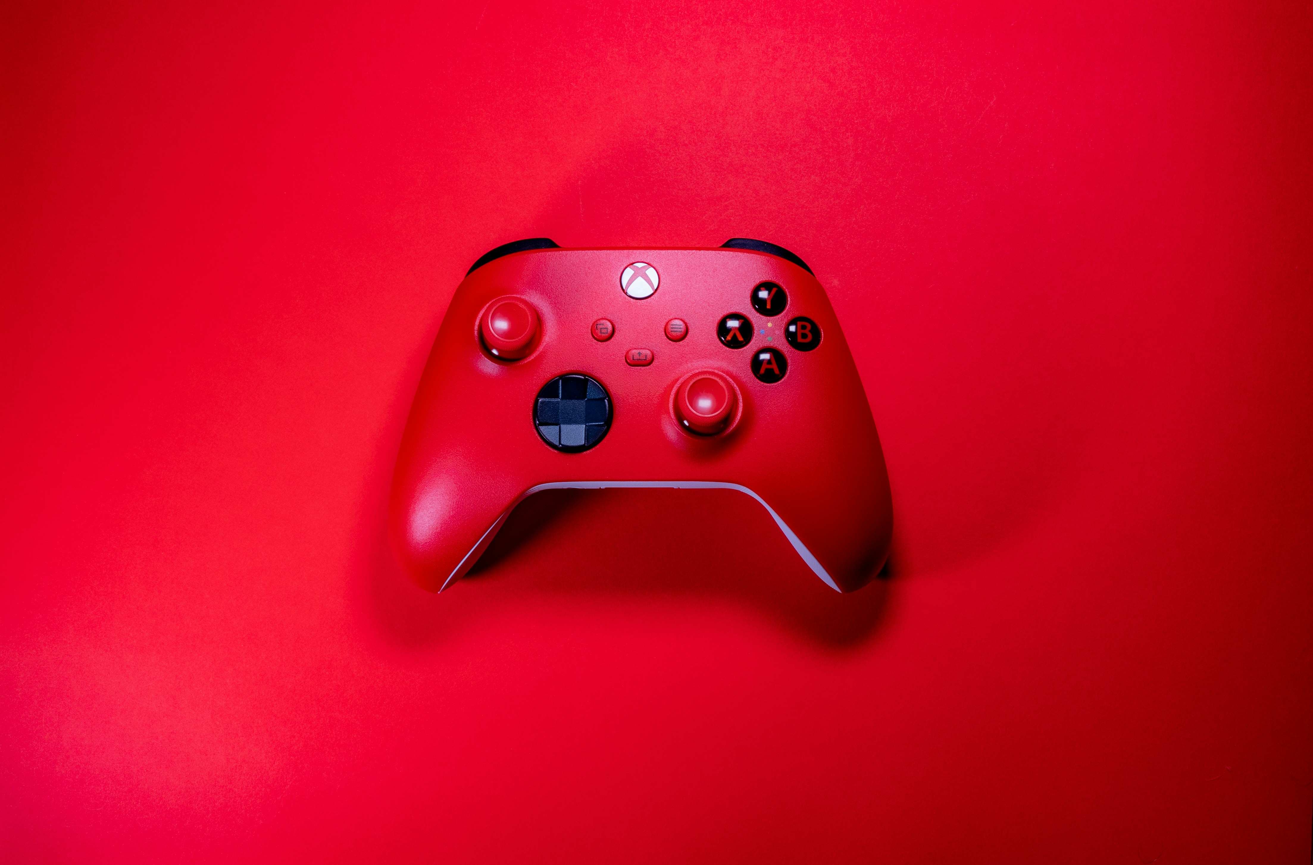 A close up of a red controller on a red surface photo – Free ...