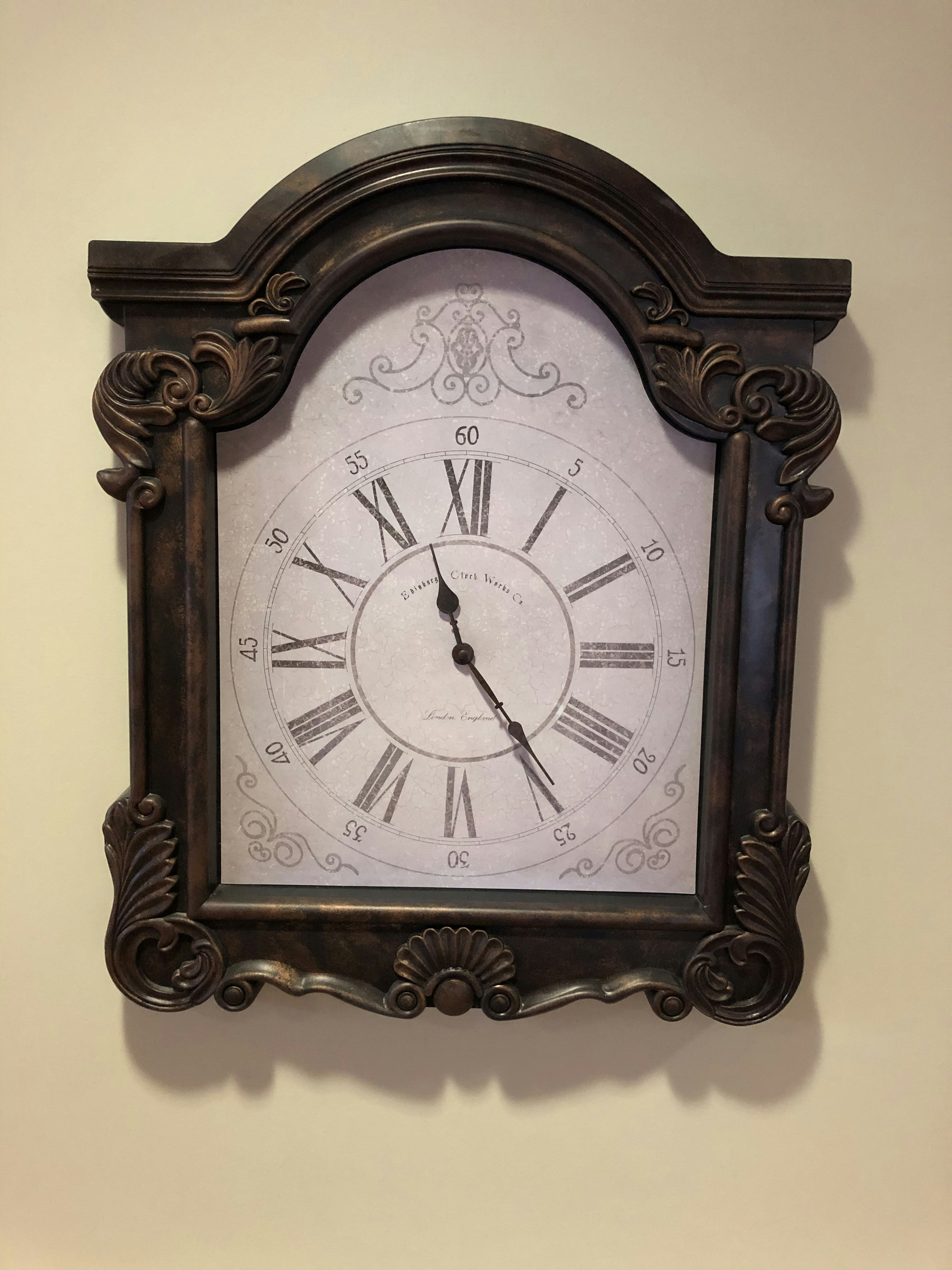 Ornate Pendulum Clock Framed in Vintage Crest