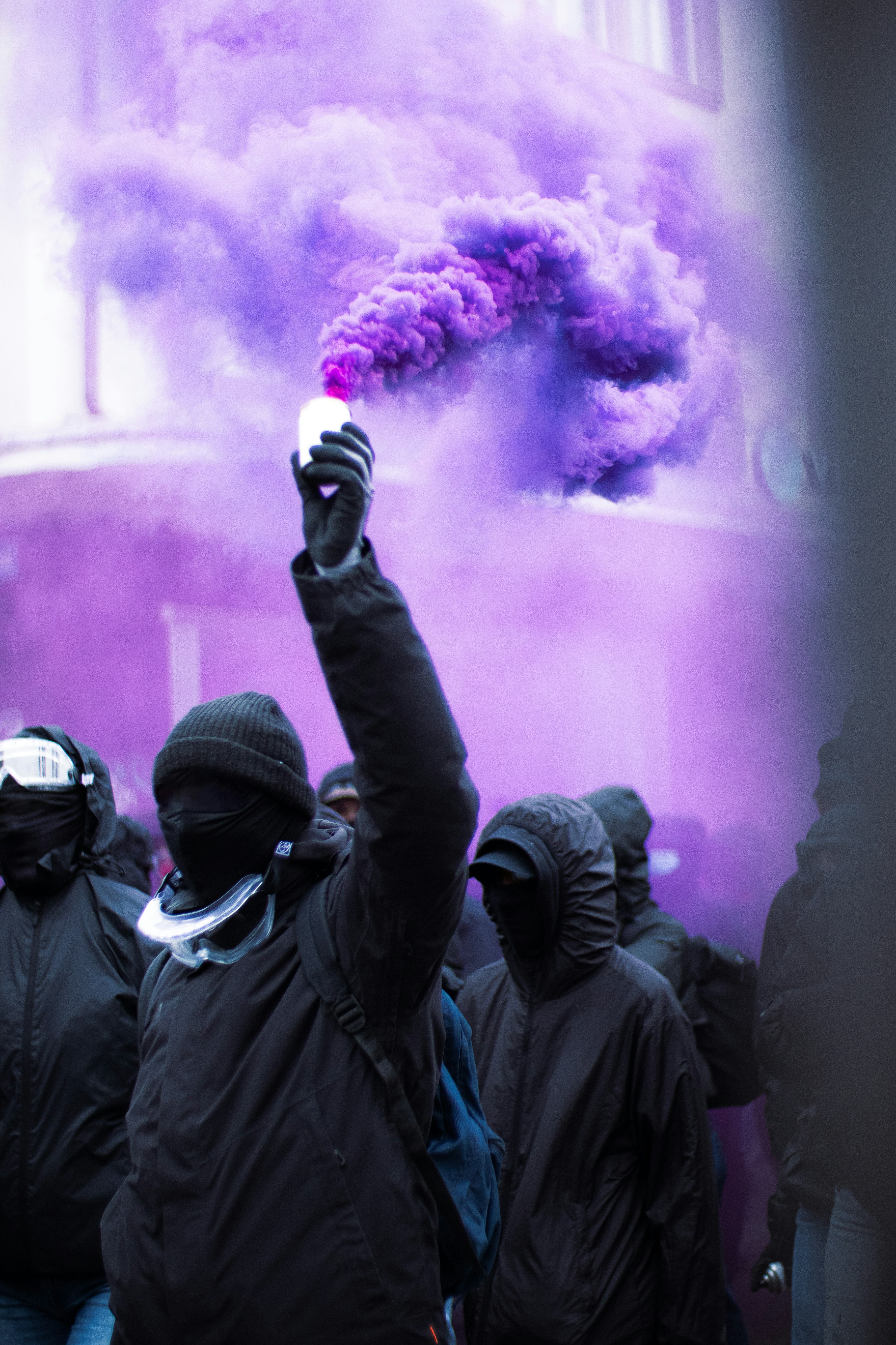 A group of people standing in front of a purple smoke bomb photo – Free ...