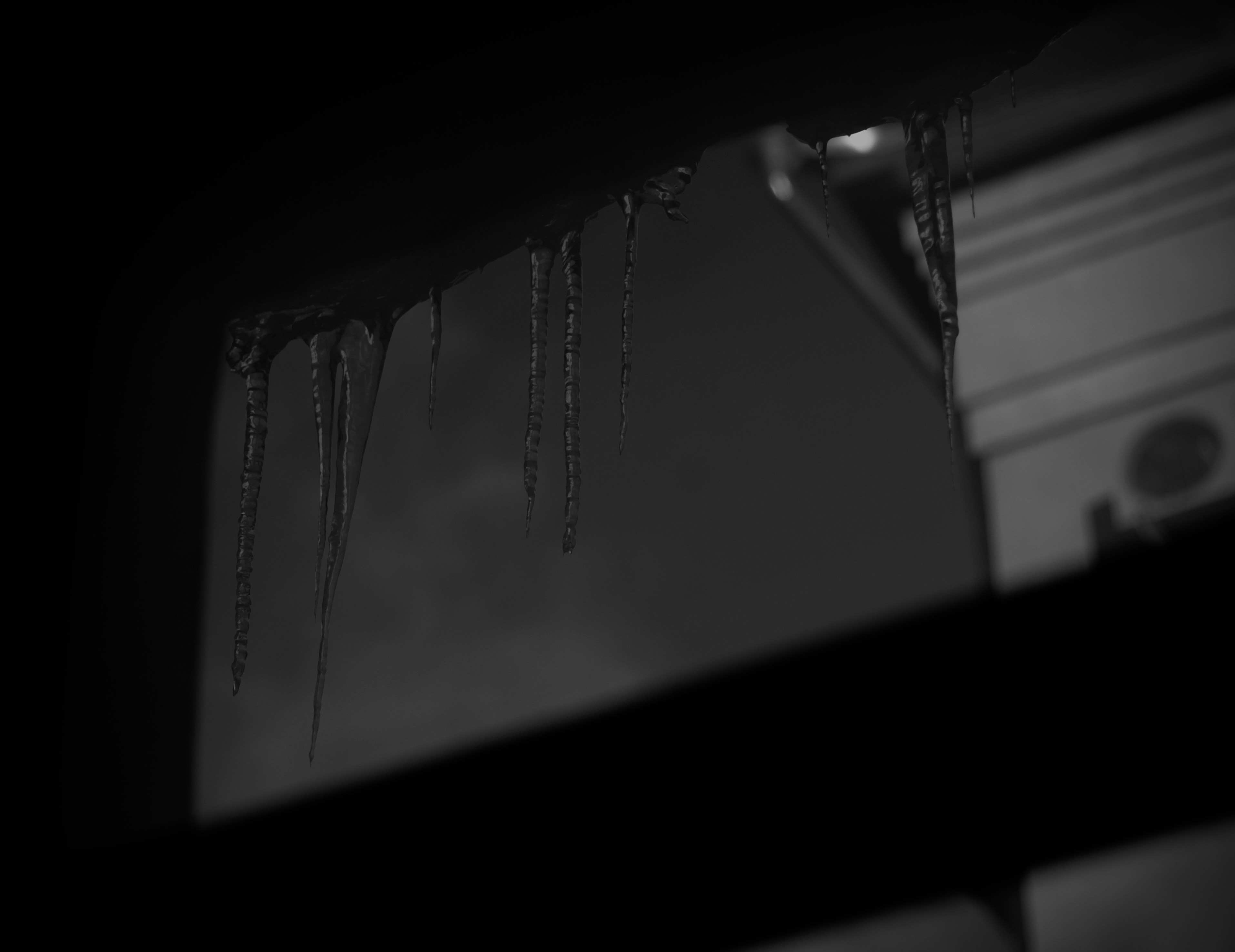 Tilted Window Icicles: A Quiet Study in Shadow and Ice
