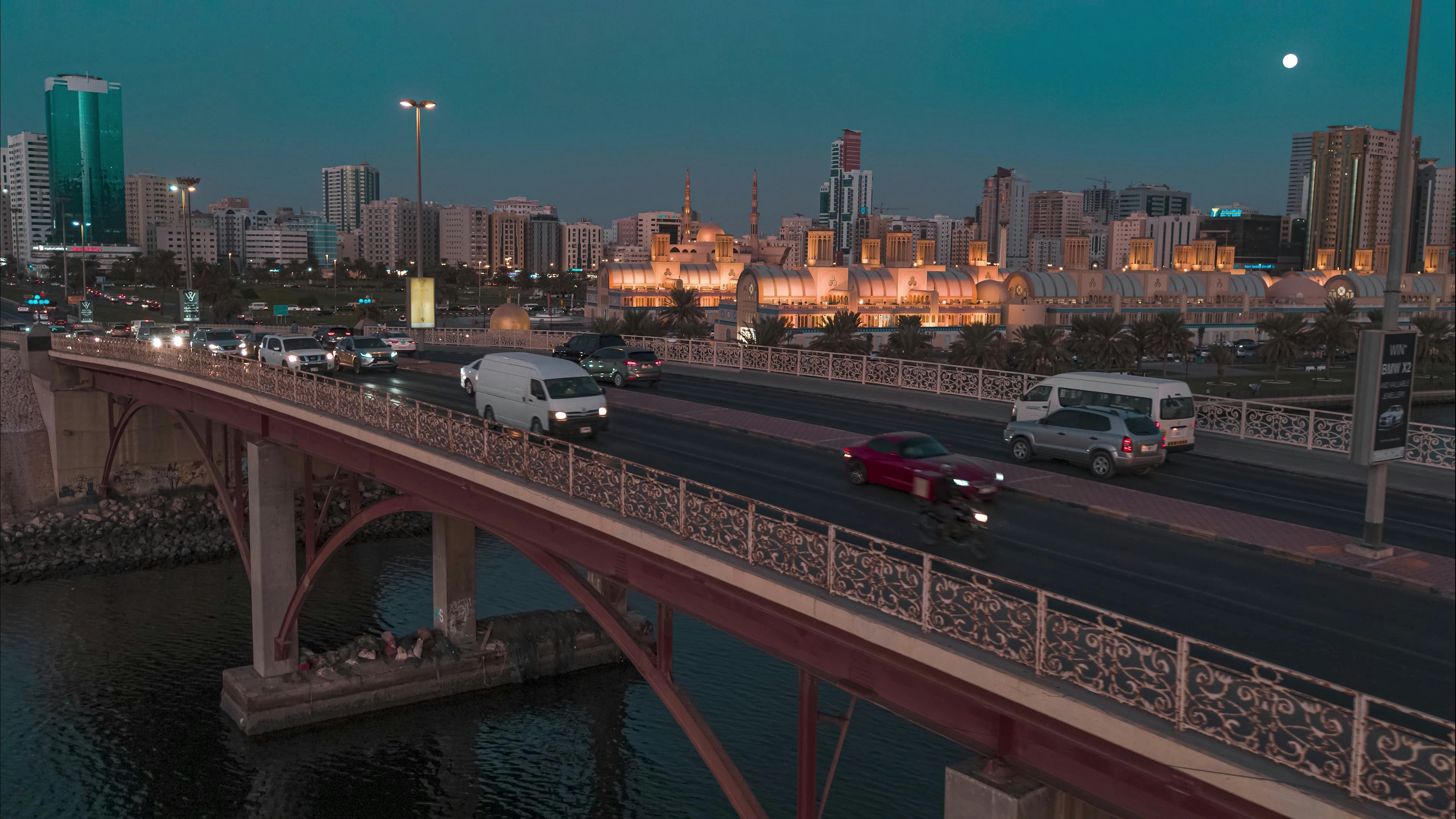 A bridge over a river with cars driving on it photo – Free Sharjah ...