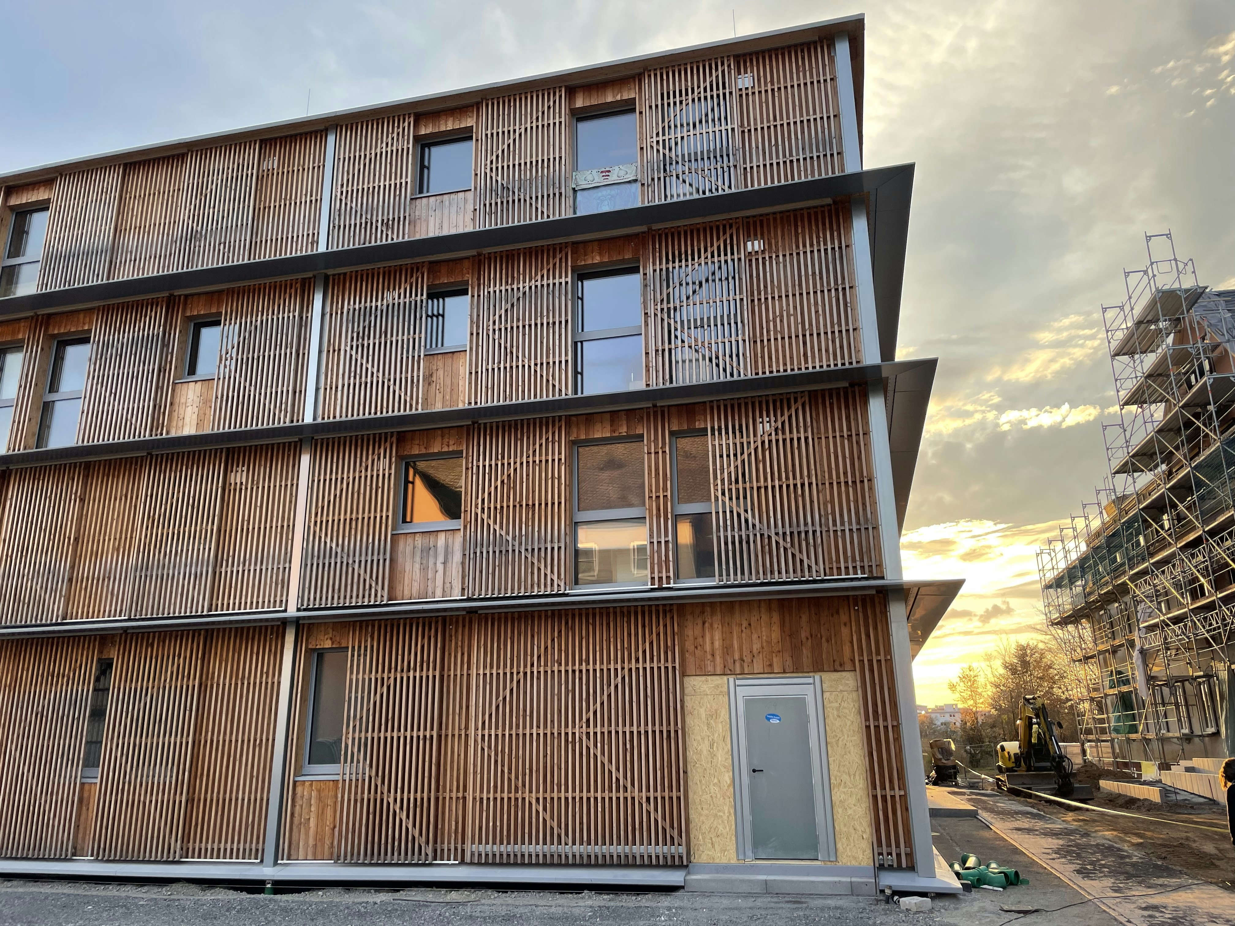 A large wooden building with lots of windows photo – Free City Image on ...