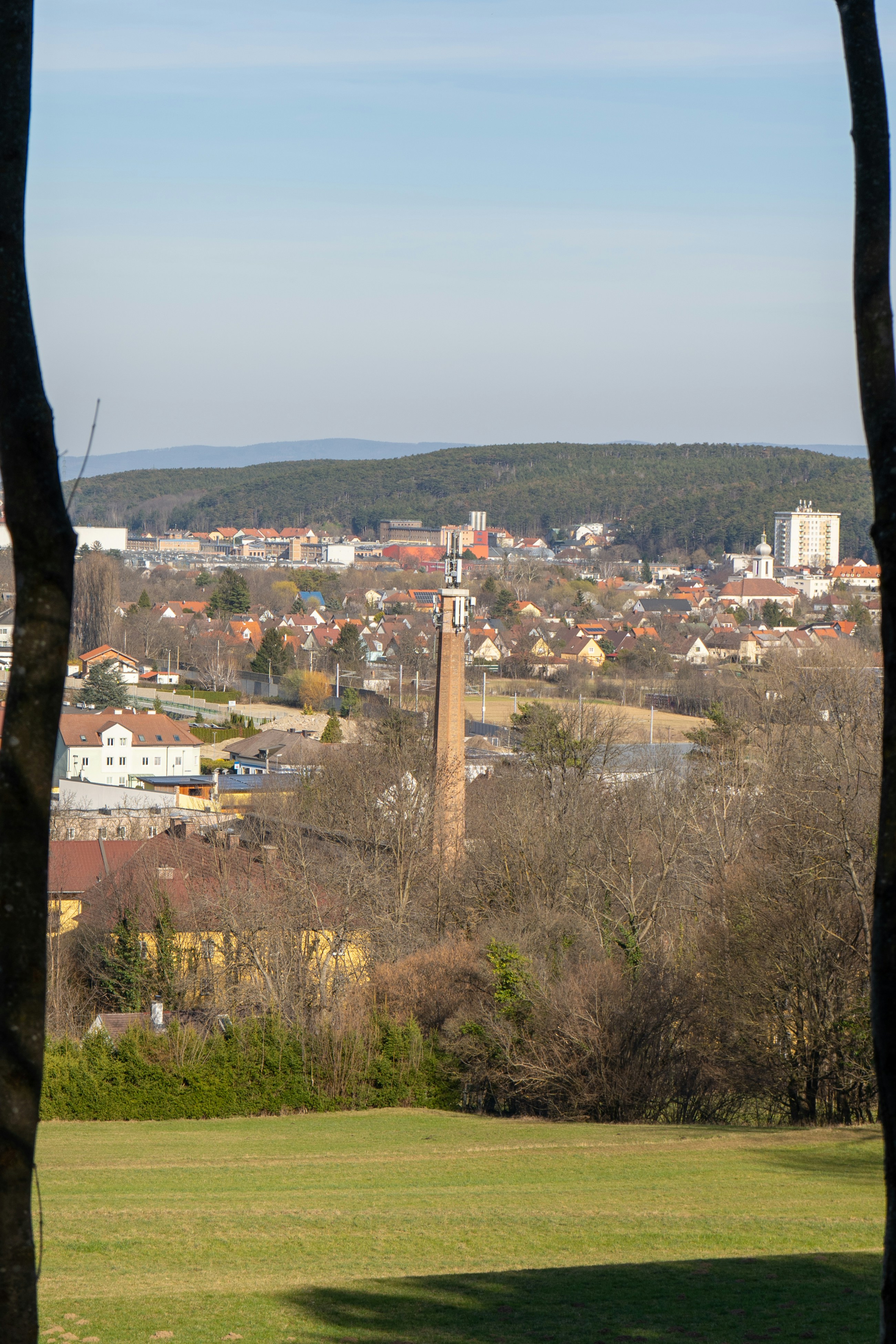 Brick Chimney Framed: A Quiet Town Under a Broad Sky