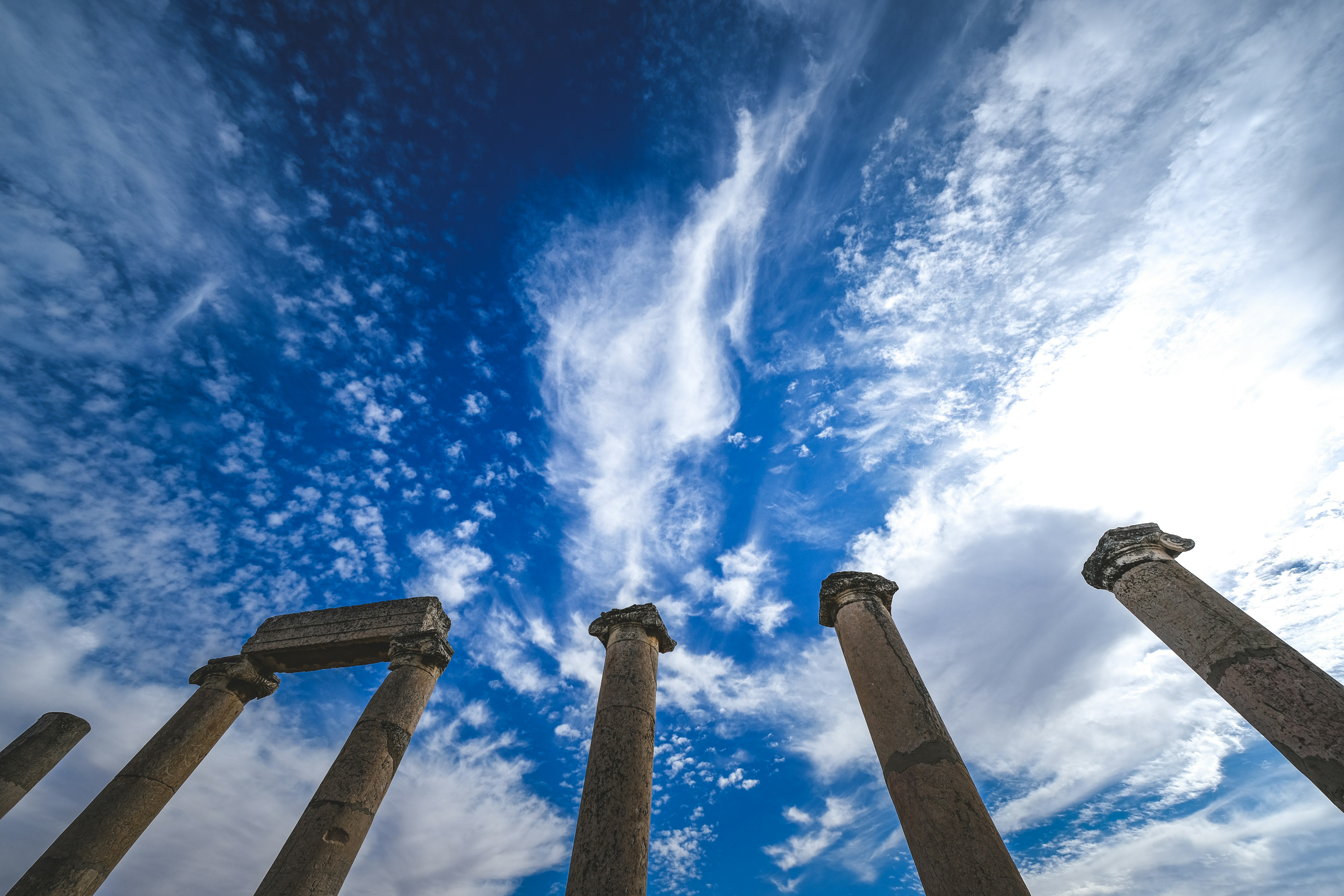 A group of tall pillars sitting under a blue sky photo – Free Nature ...