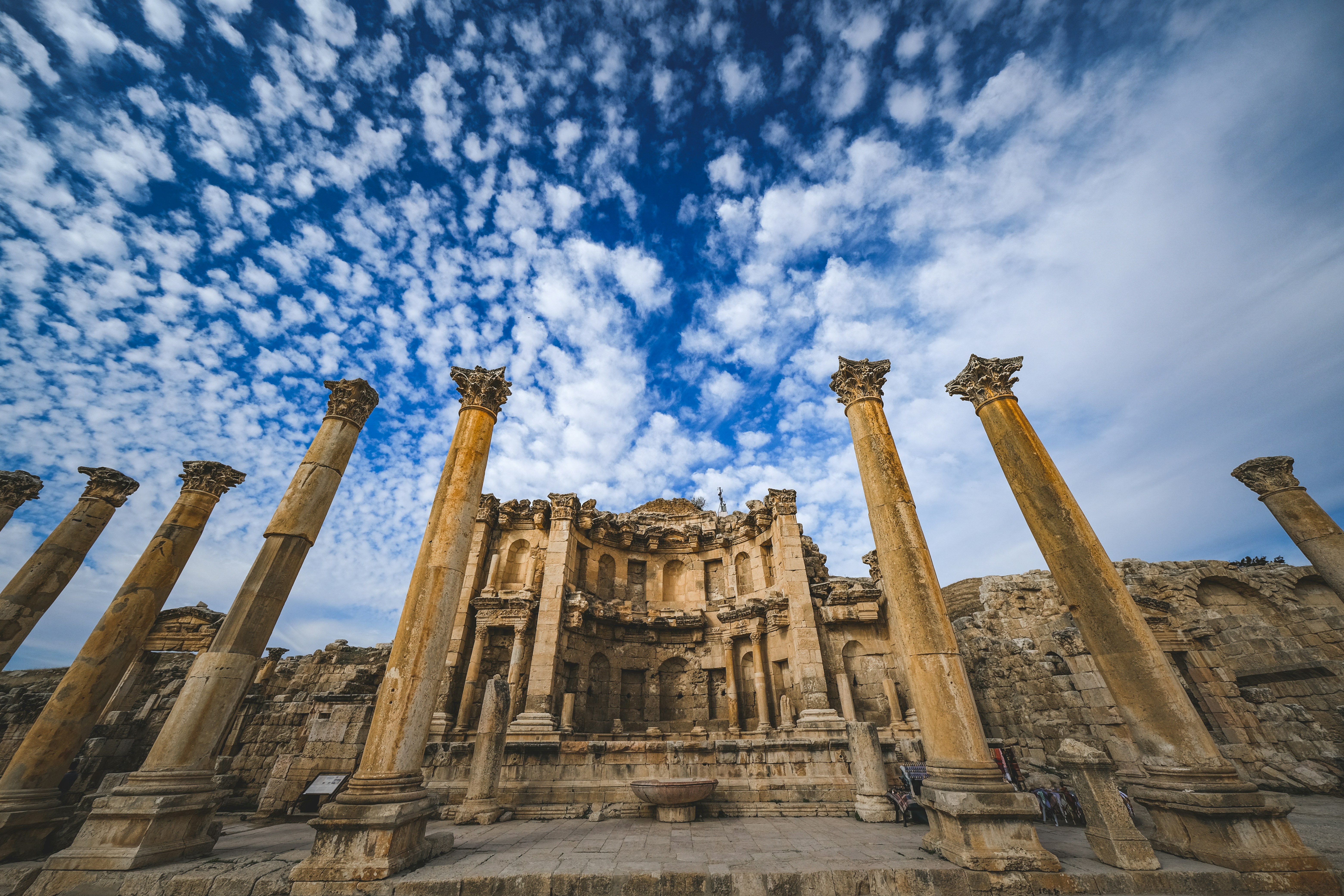 The ruins of the ancient city of palmyran under a cloudy blue sky photo ...