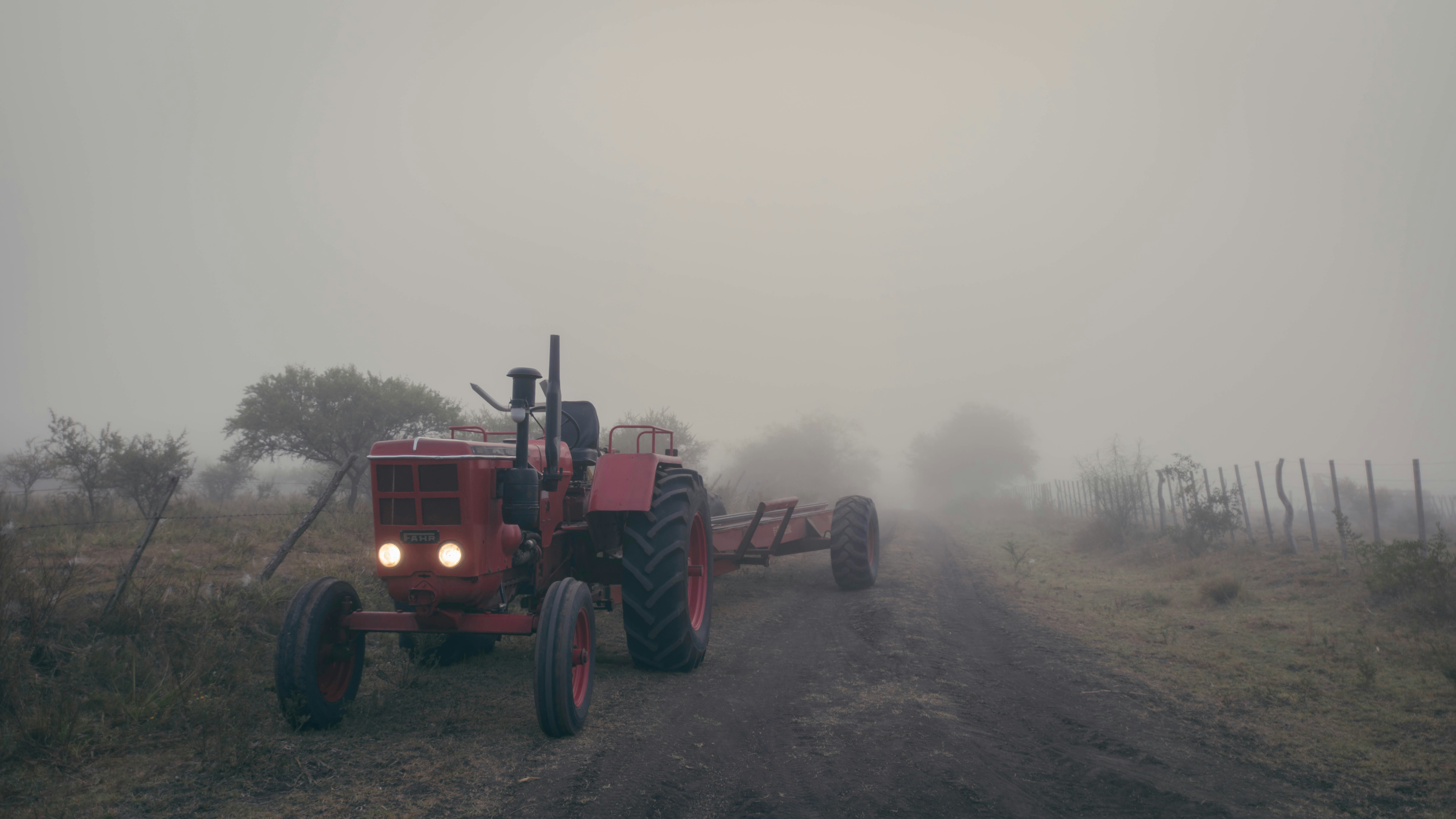 Red Tractor in the Mist: Hauling Through a Foggy Farm Road