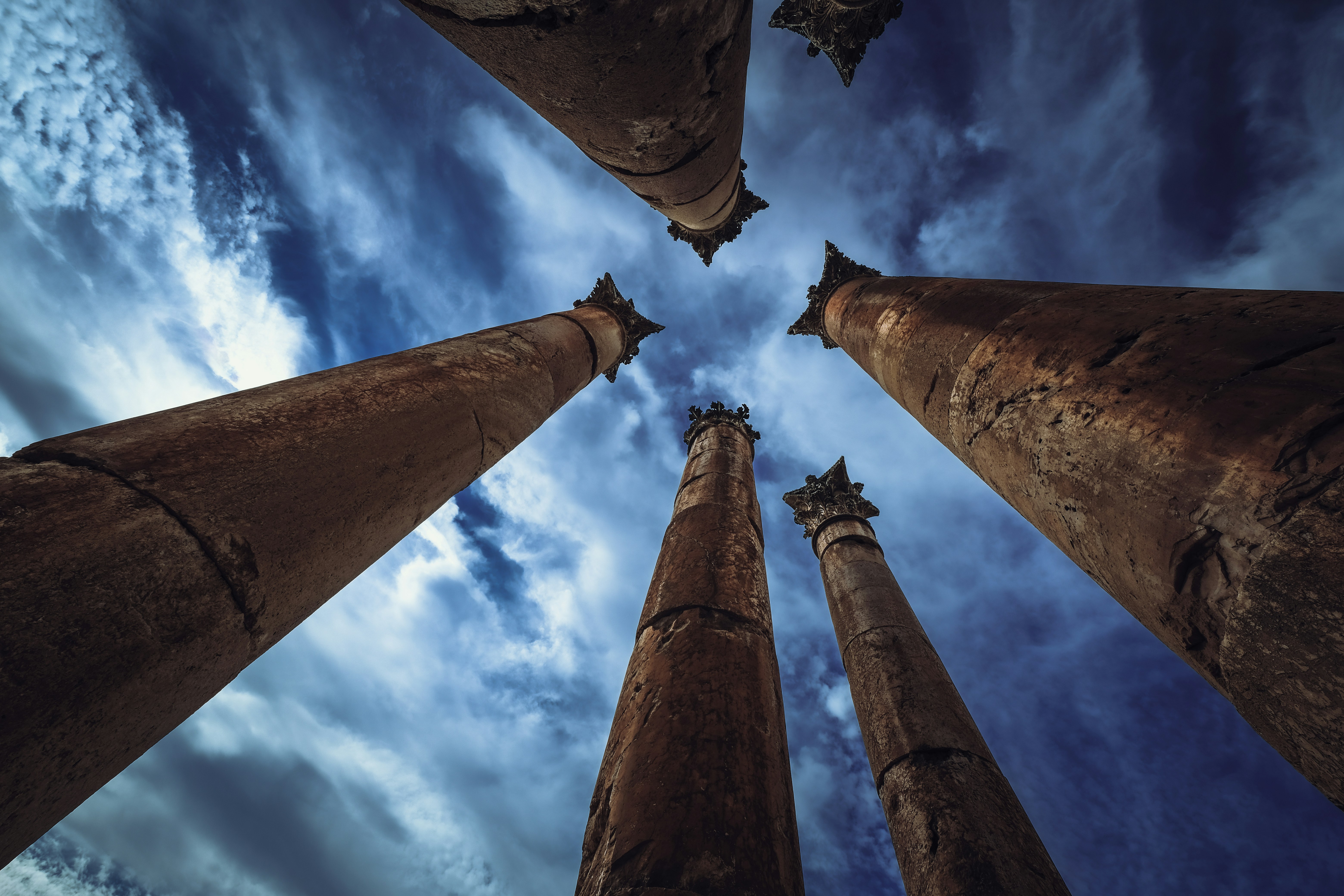 A group of tall pillars standing next to each other photo – Free Pillar ...