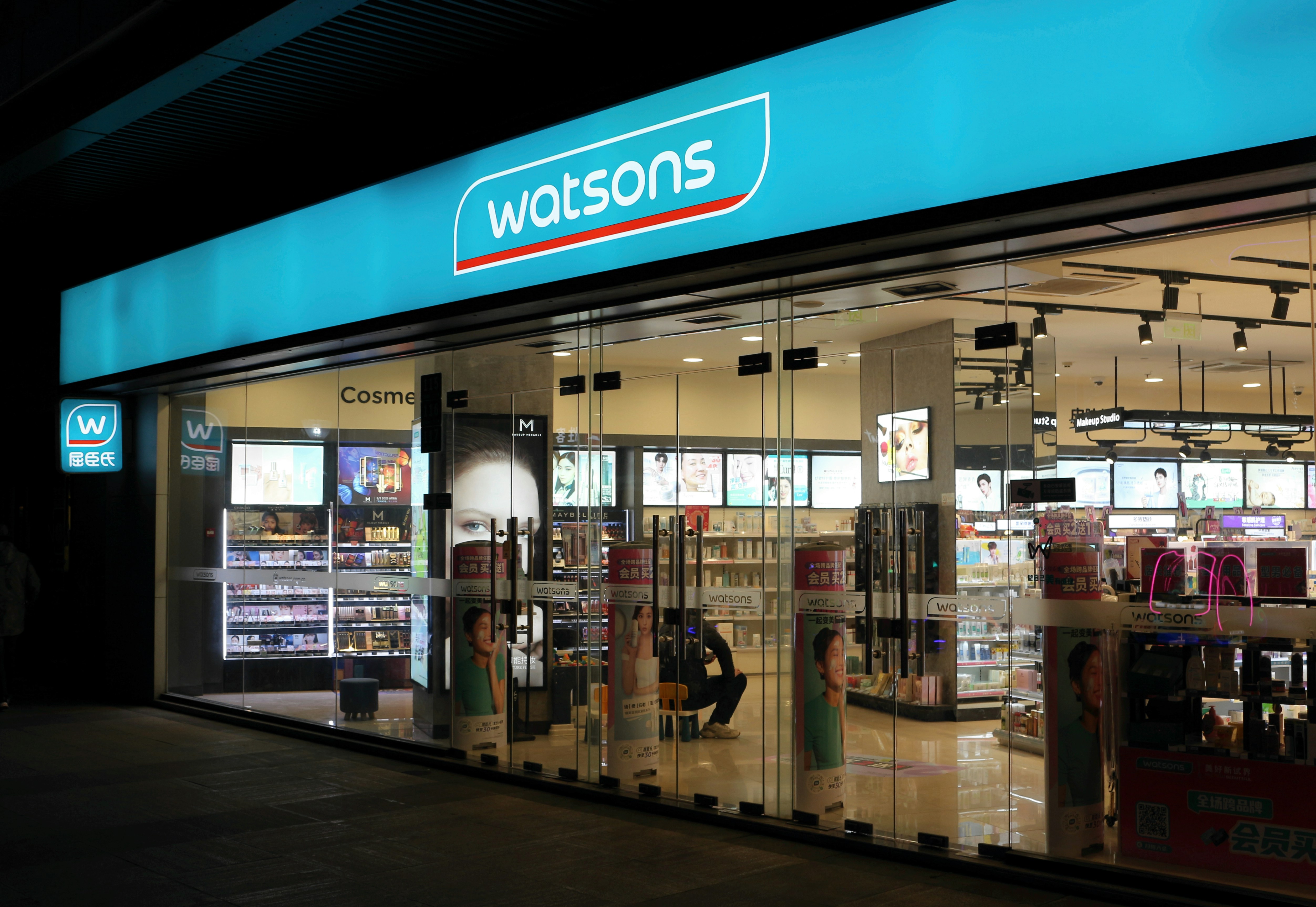 A walgreens store front at night with people walking by photo – Free ...